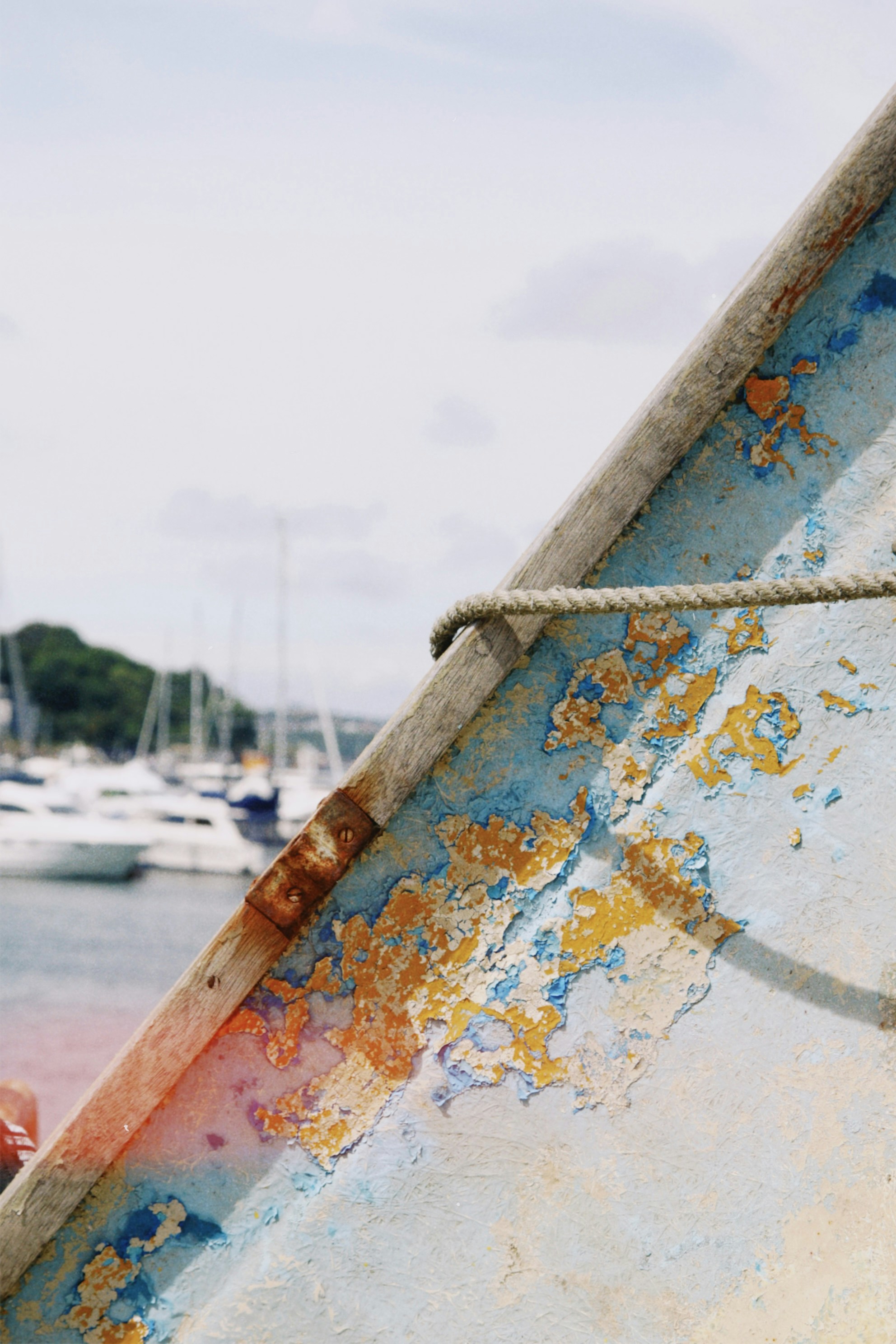 Weathered hull, color chips, and rope: a slice of harbor life