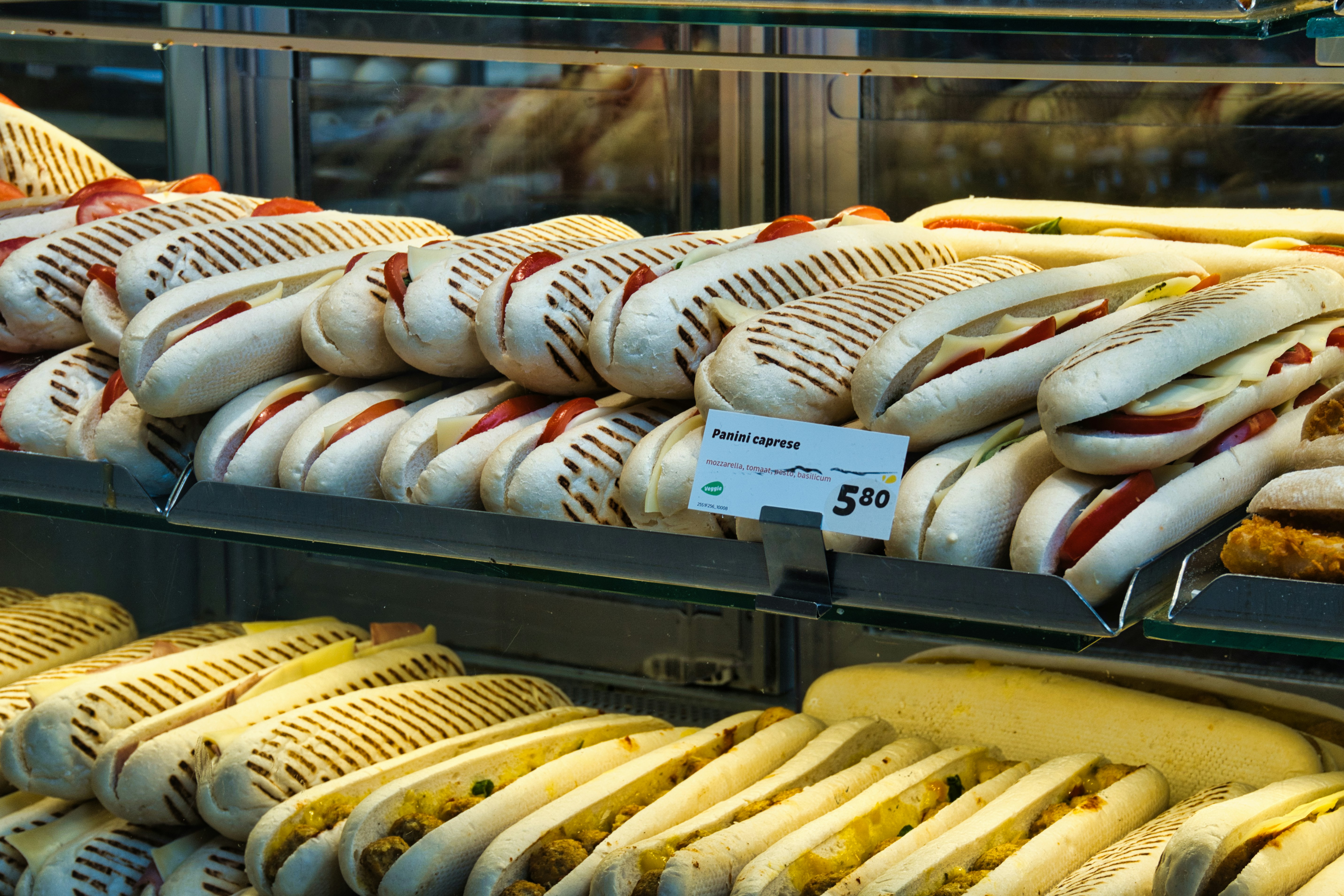 Bread display in a shop. | Sandwiches are displayed inside a bakery.