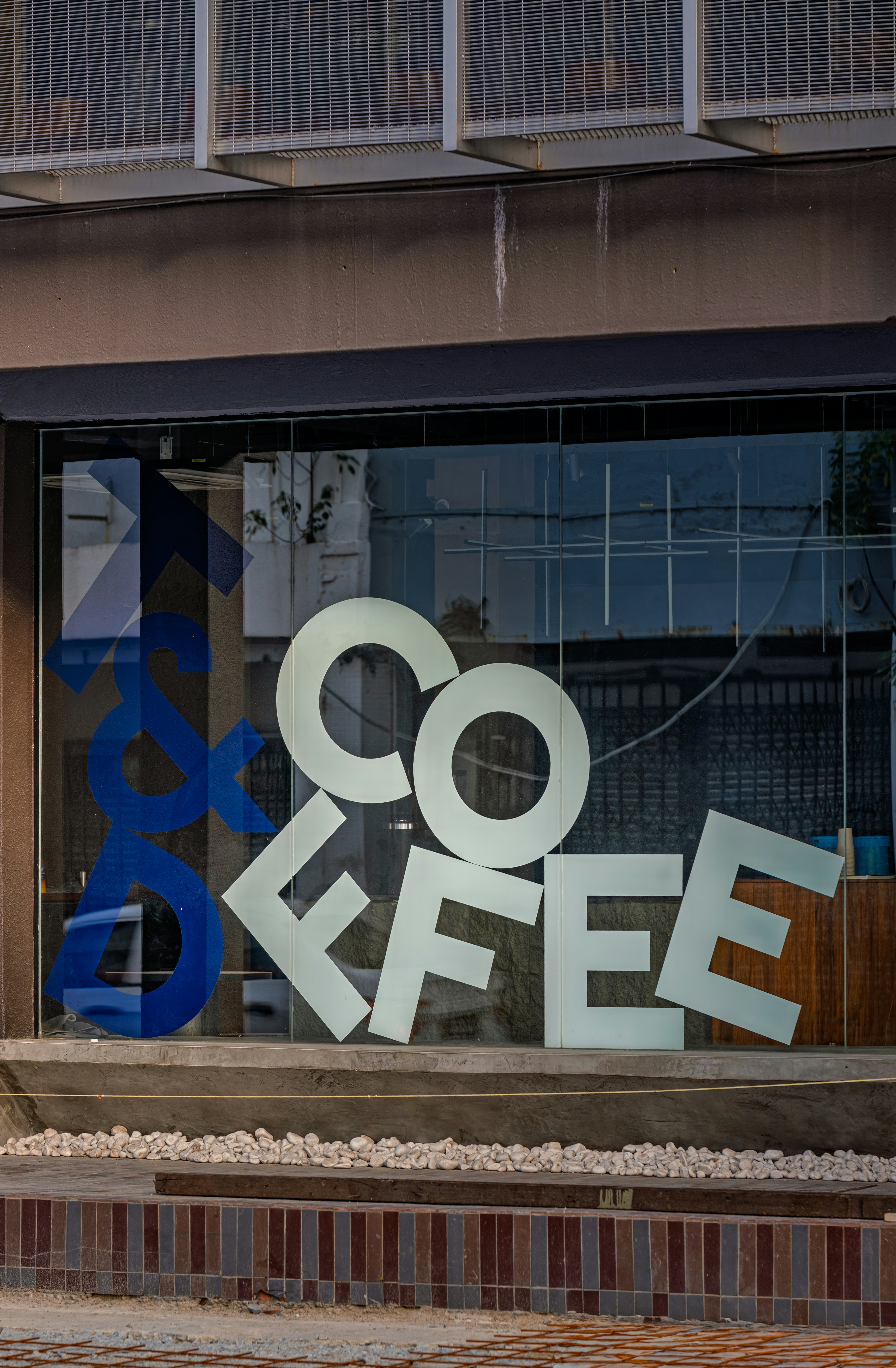 Geometric “CO” and letters in a Glass Storefront