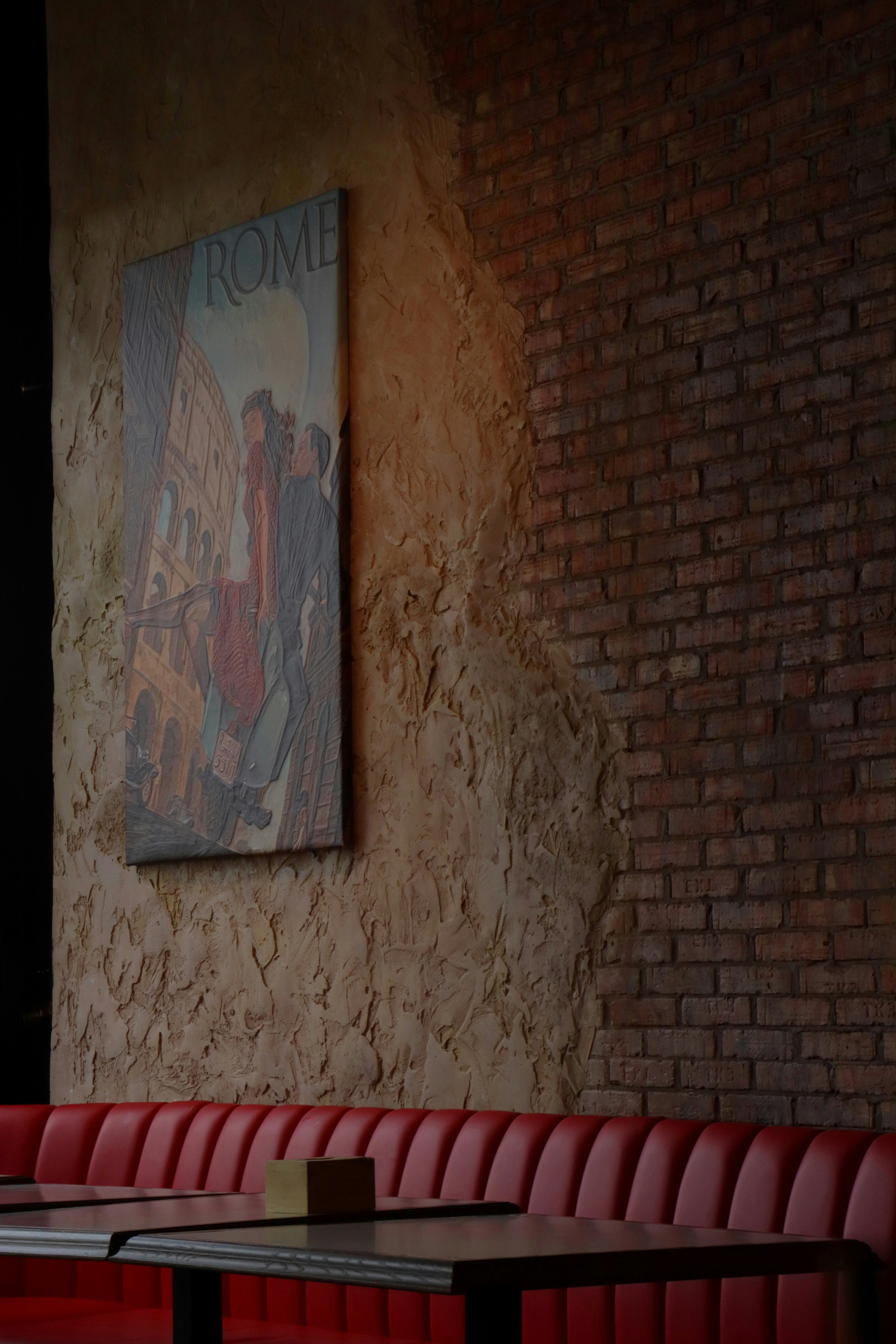 A vintage "rome" poster hangs on the wall. photo – Free Red background ...