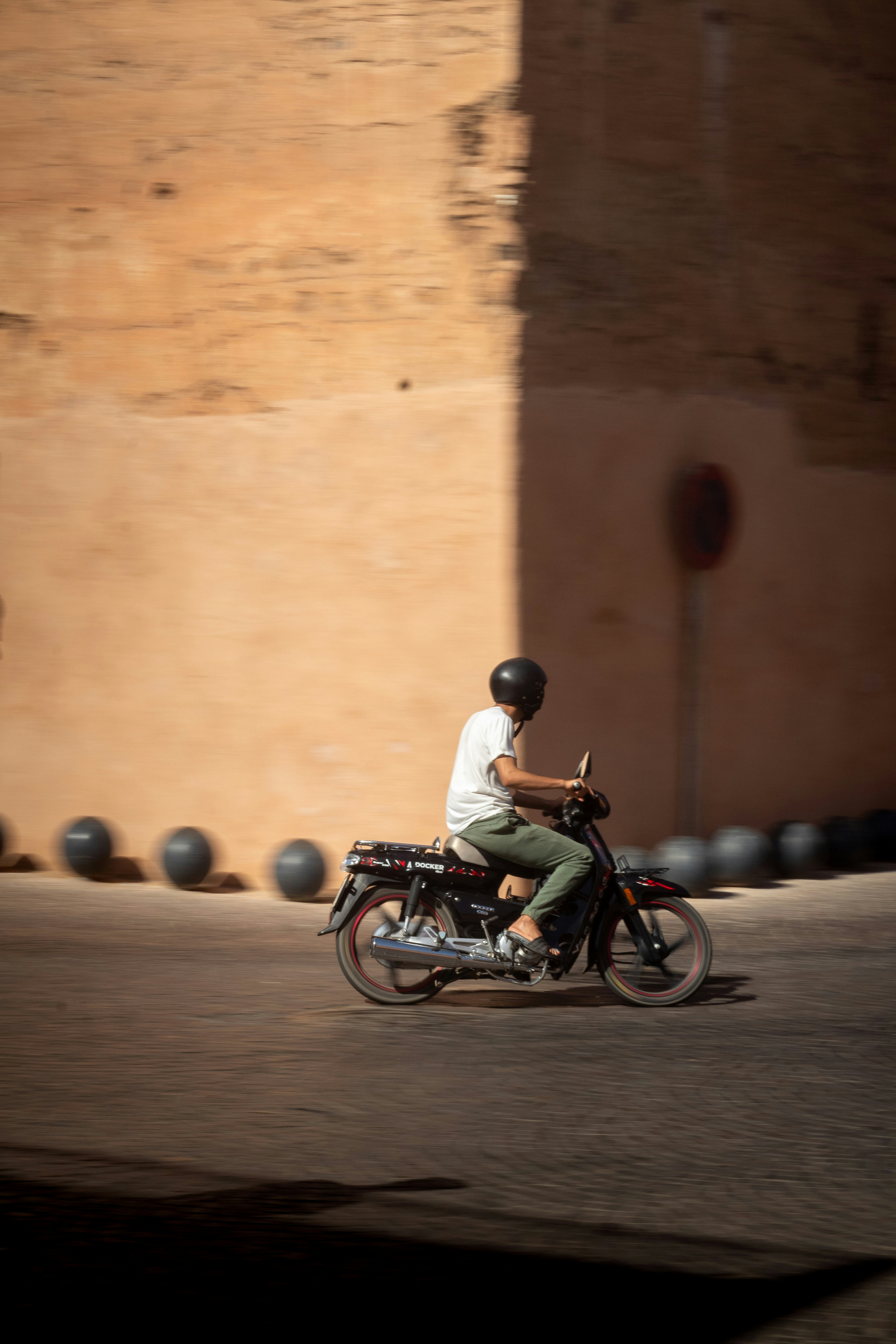 Lone Rider Gliding Past a Sun-Warmed Fortress Wall