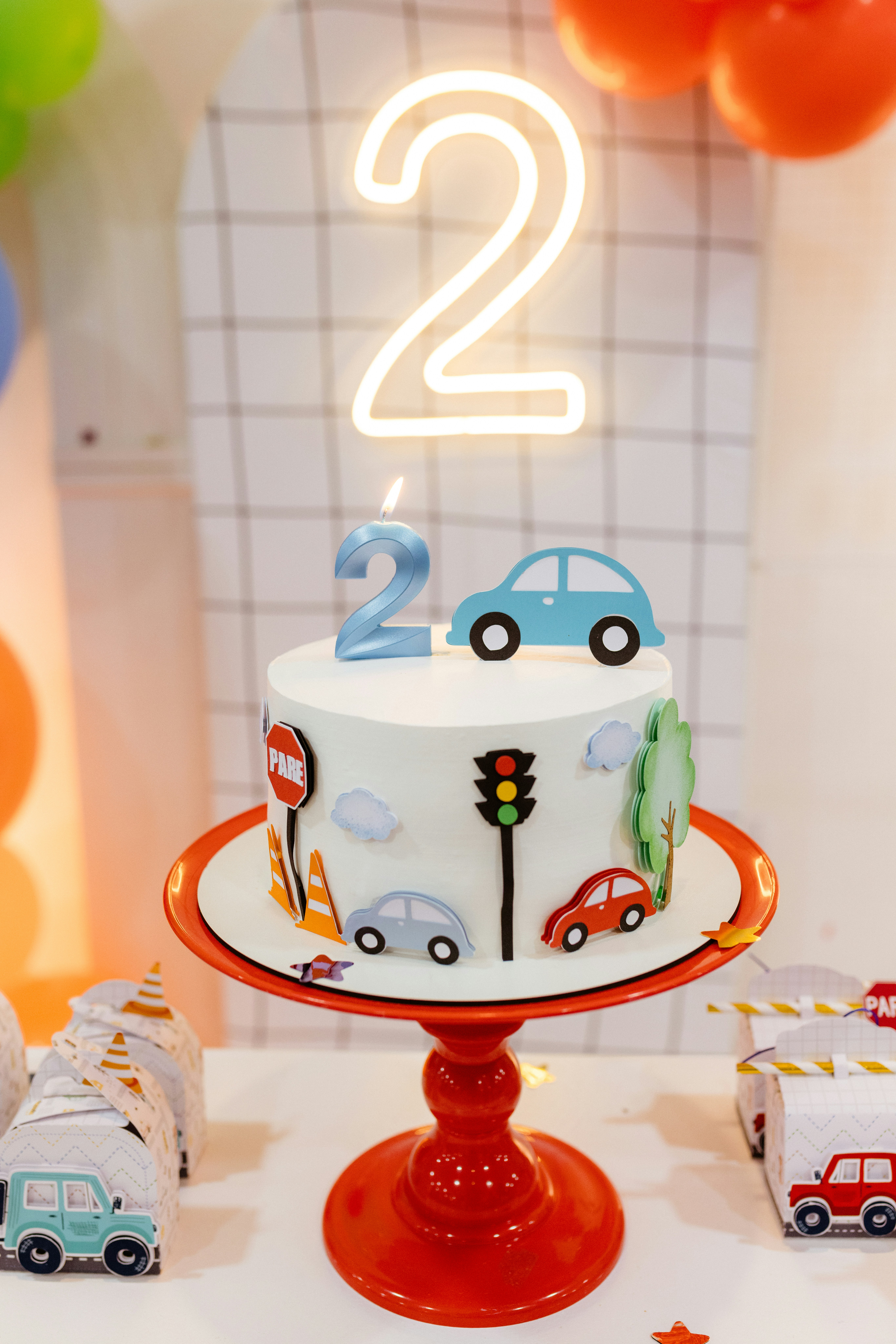 Neon Two Over a Cityscape Cake on a Crimson Pedestal