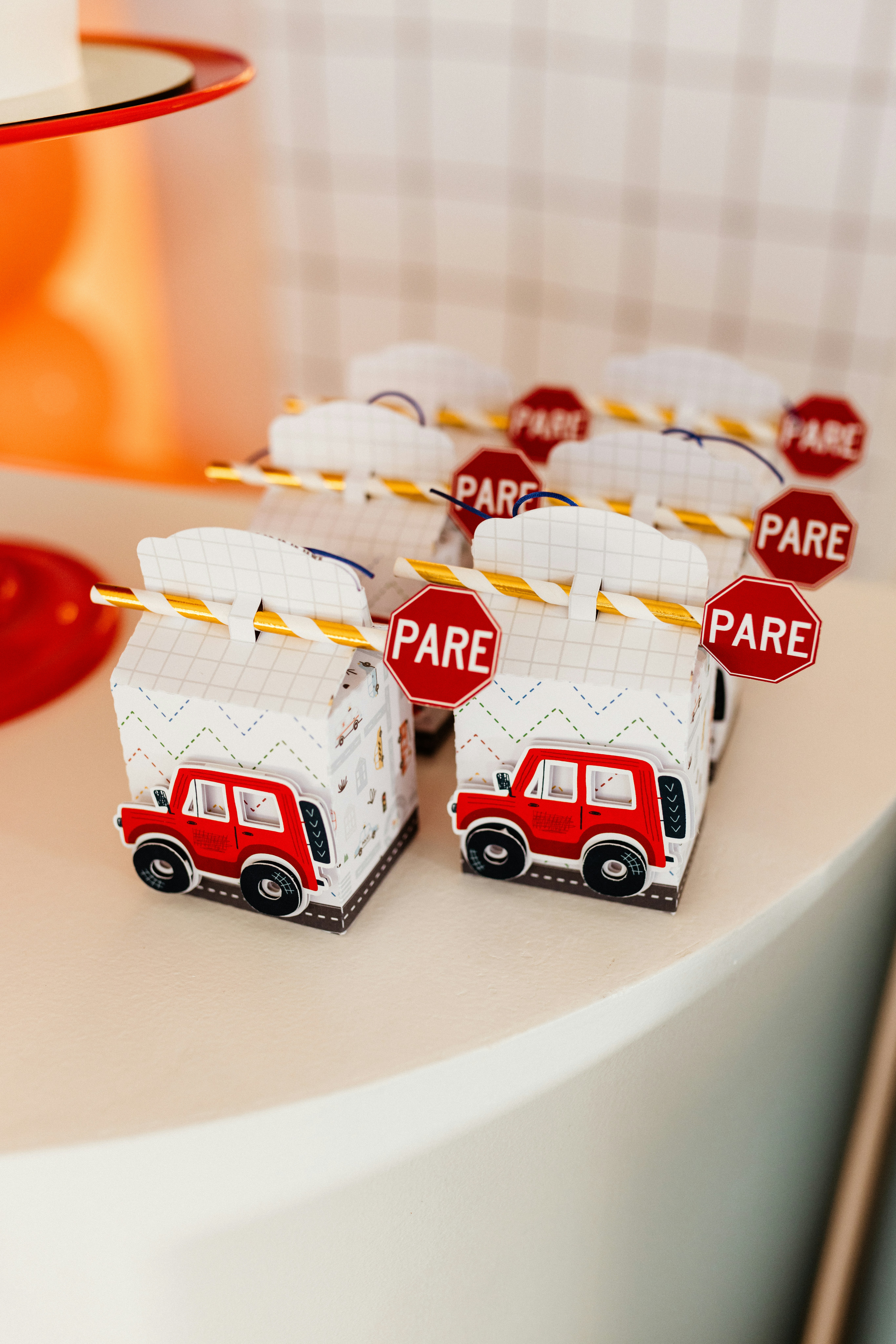Miniature Stop-Work Parade: Red Trucks and Stop Signs