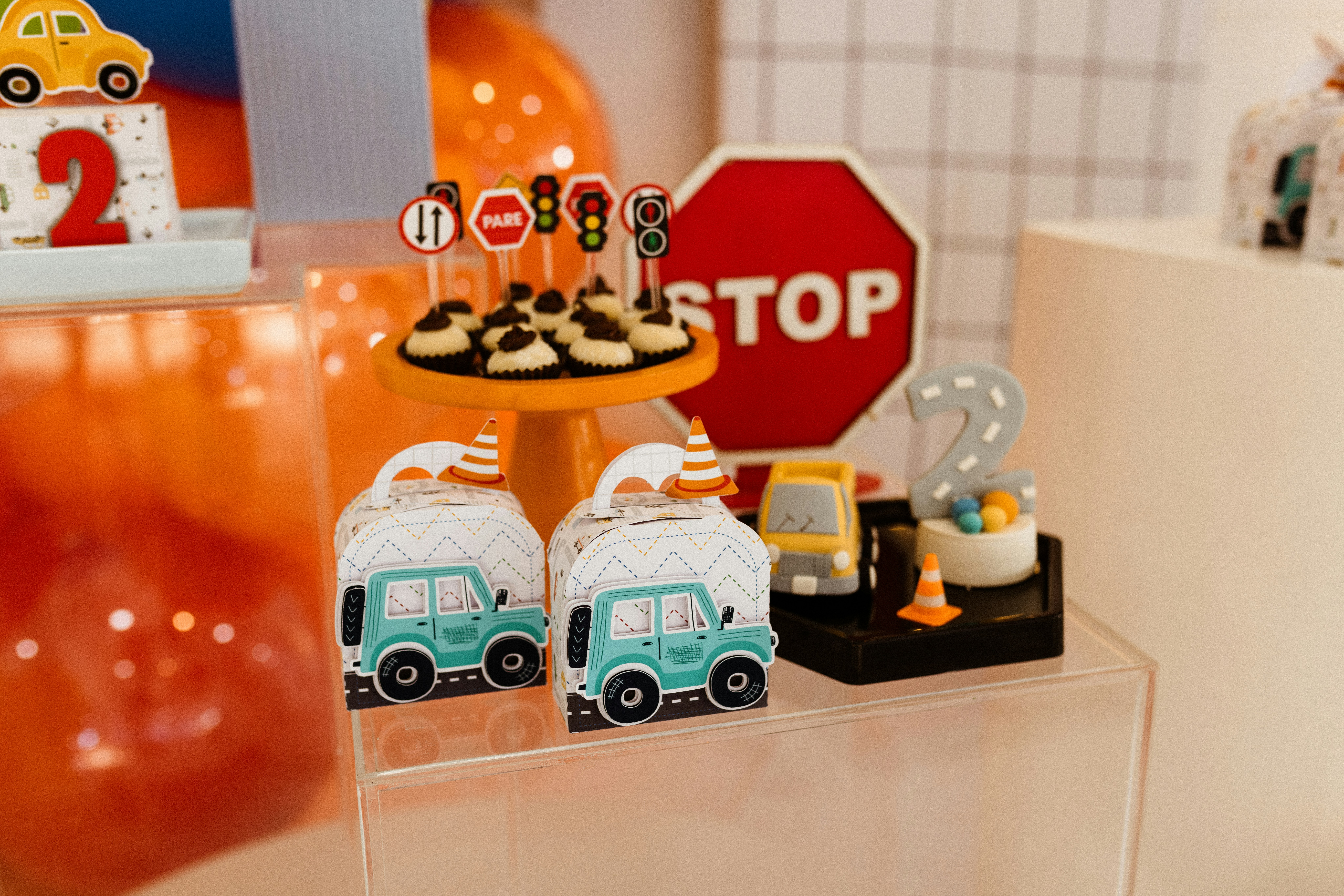 Miniature Roadside Scene: Cars, Stop Sign, and Treats on Display