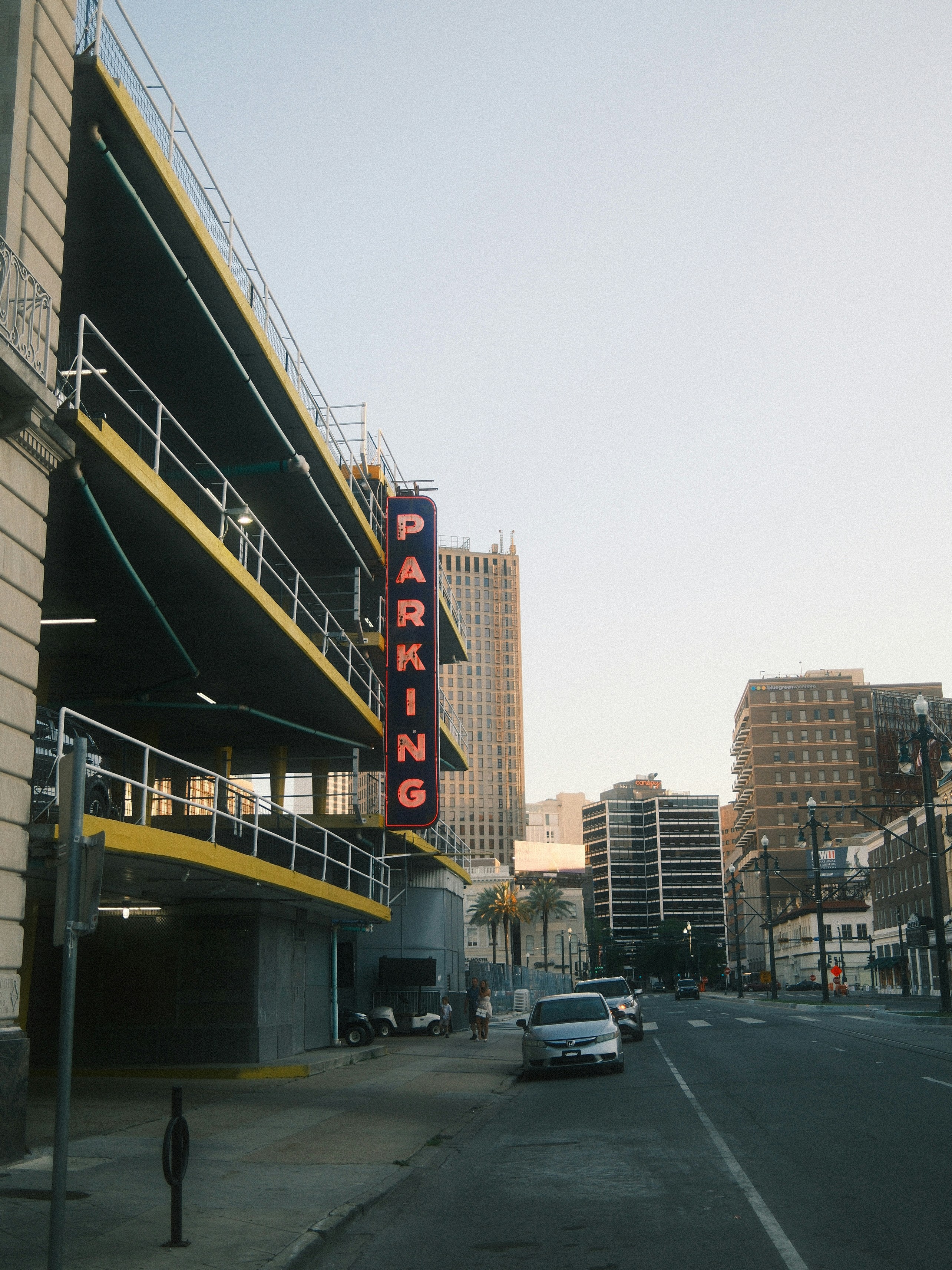 Vertical Neon Parking Sign Illuminates a Quiet Downtown Street