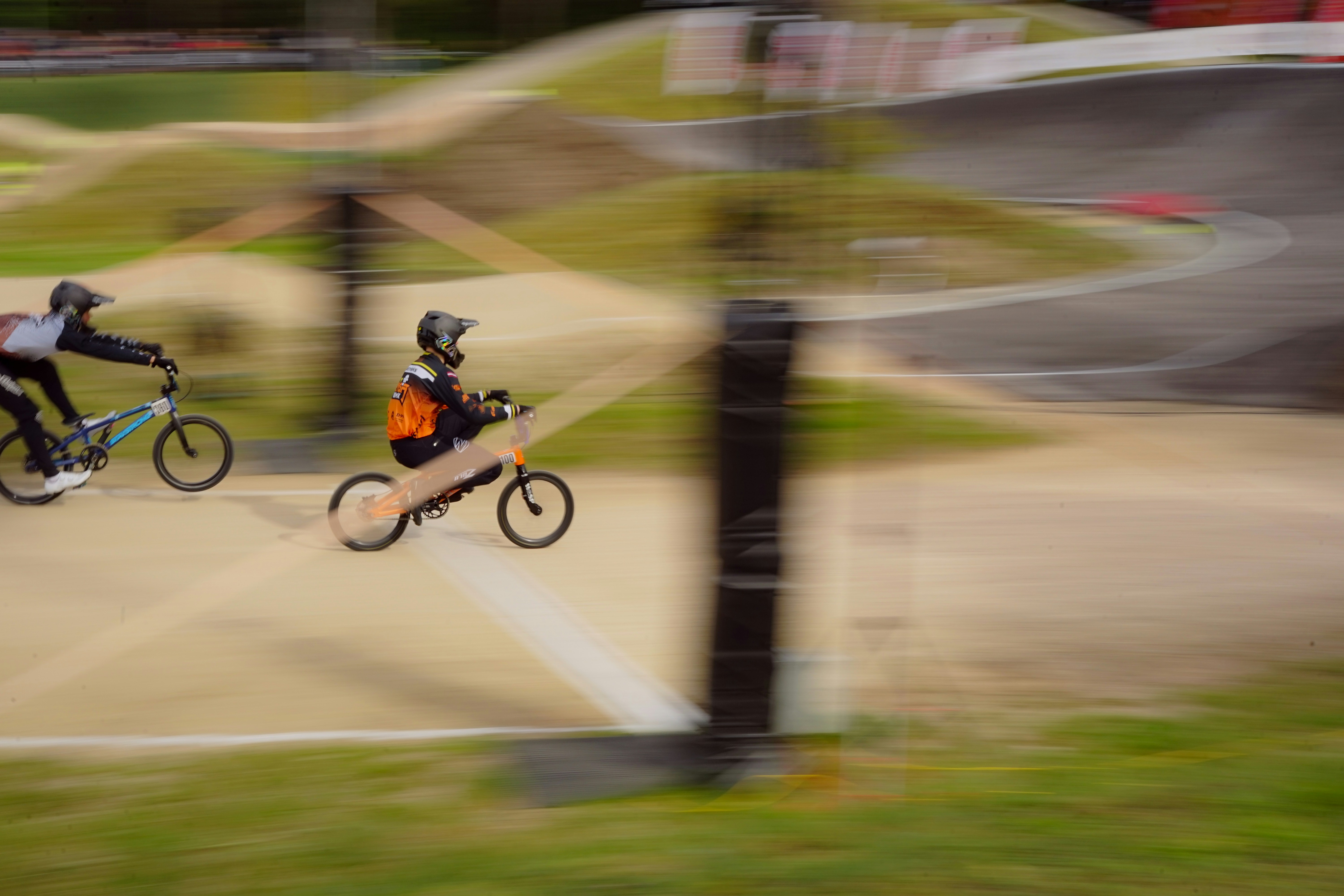 Orange Jersey Sprint Through a Motion Blur on the BMX Track