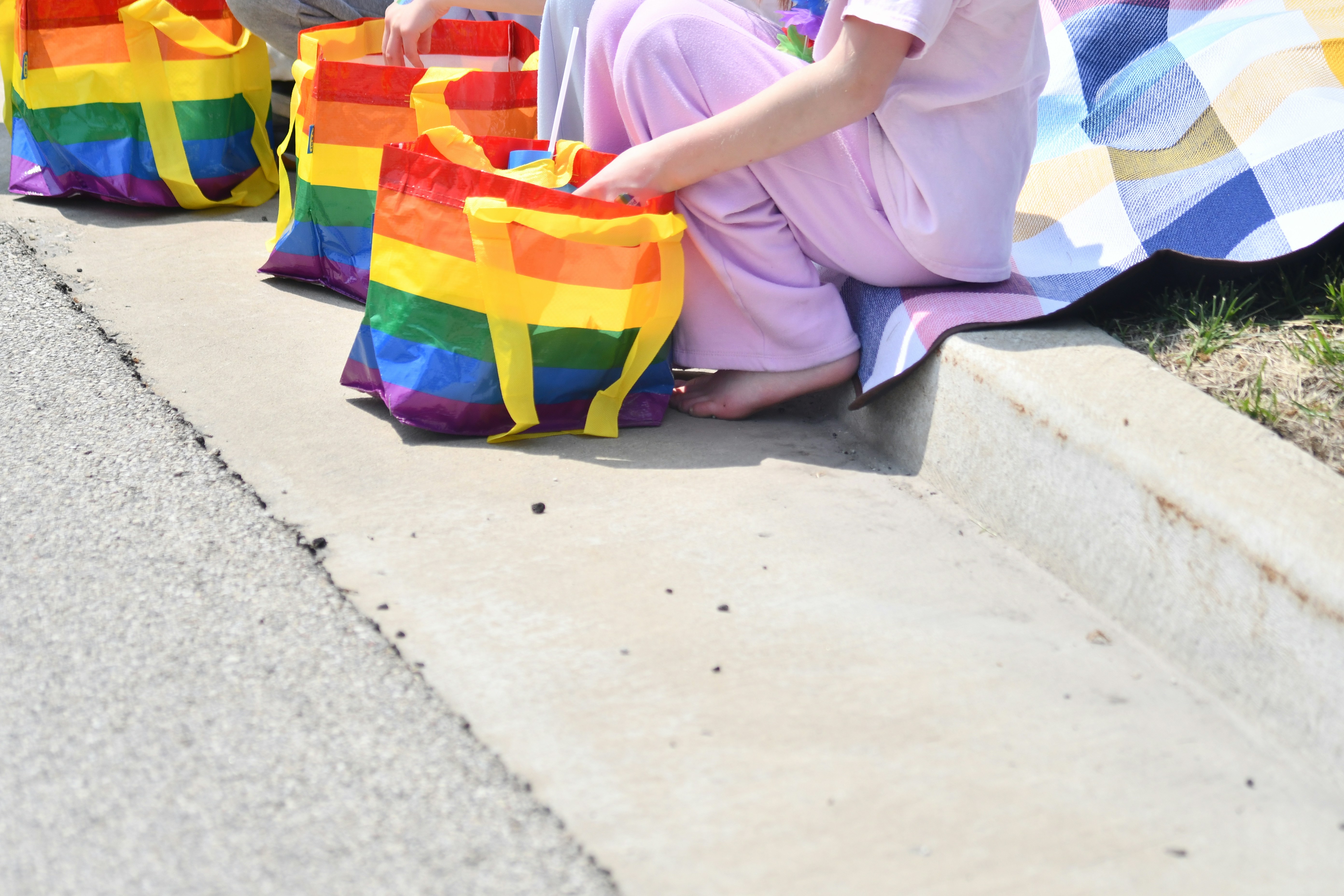Rainbow Tote Parade: Kids and Blankets on a Curb