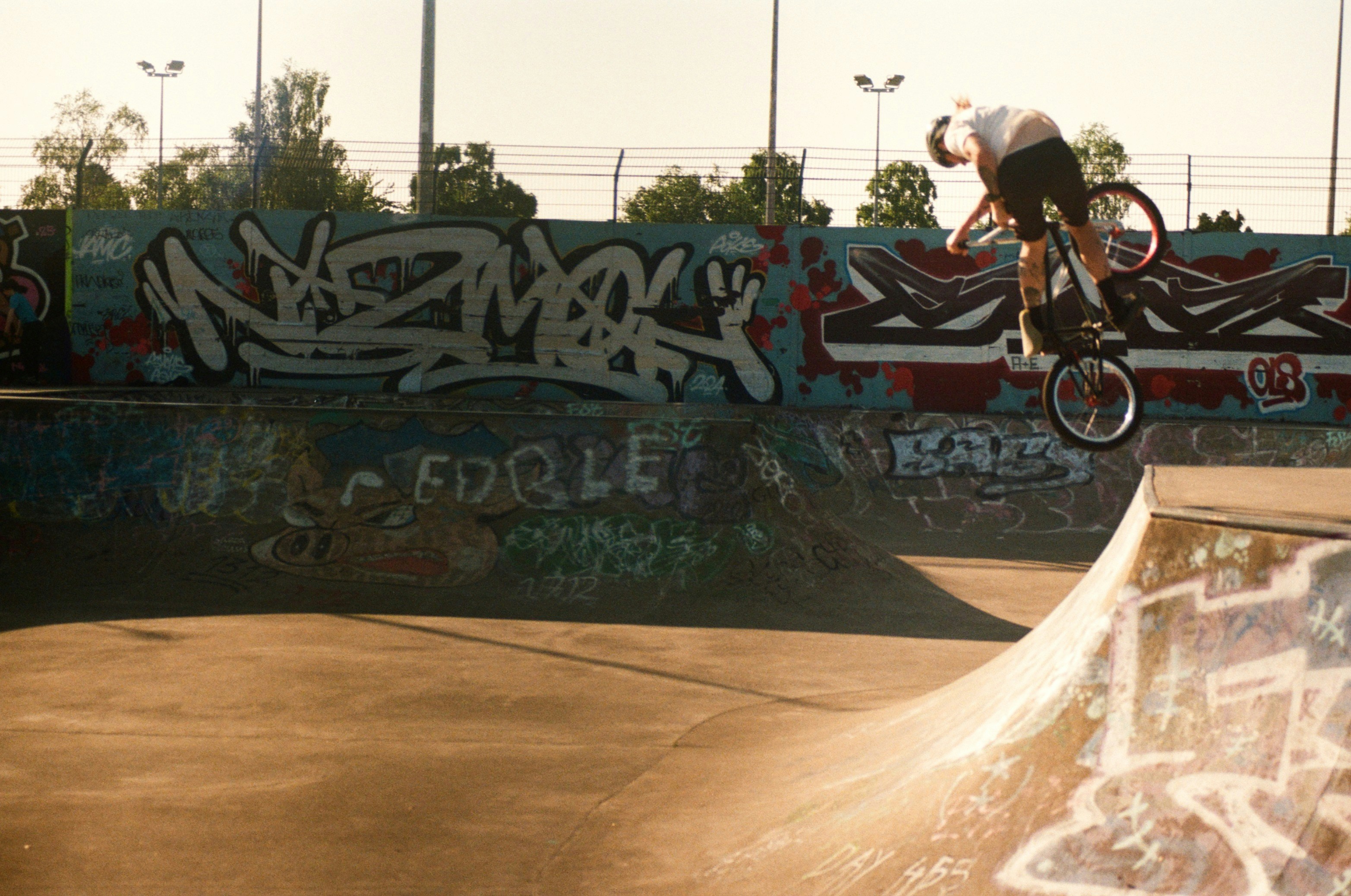 Bmx rider performs a trick at a skate park.