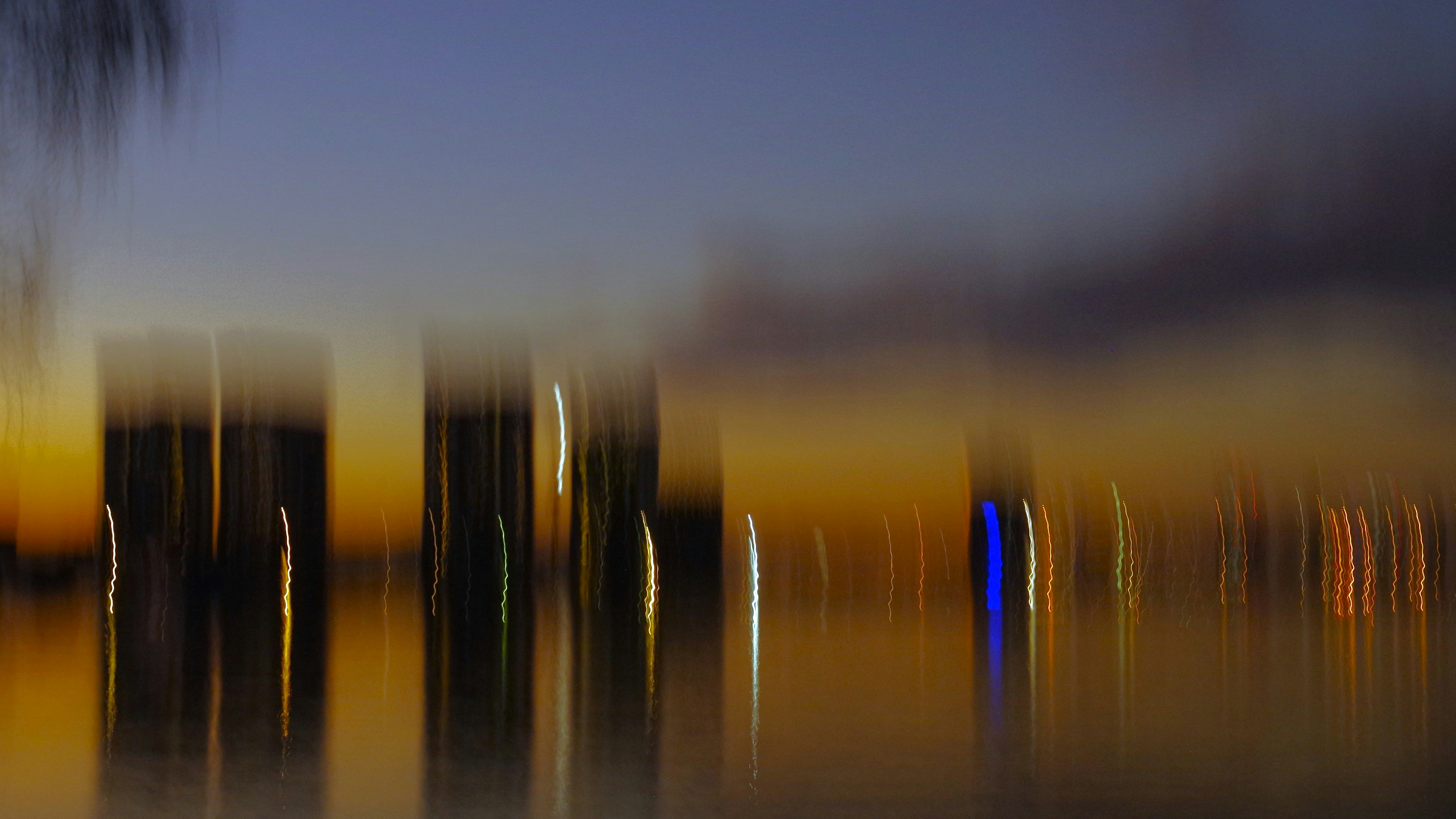 Blurry Riverside Glow: Evening Lights Turned to Streaks