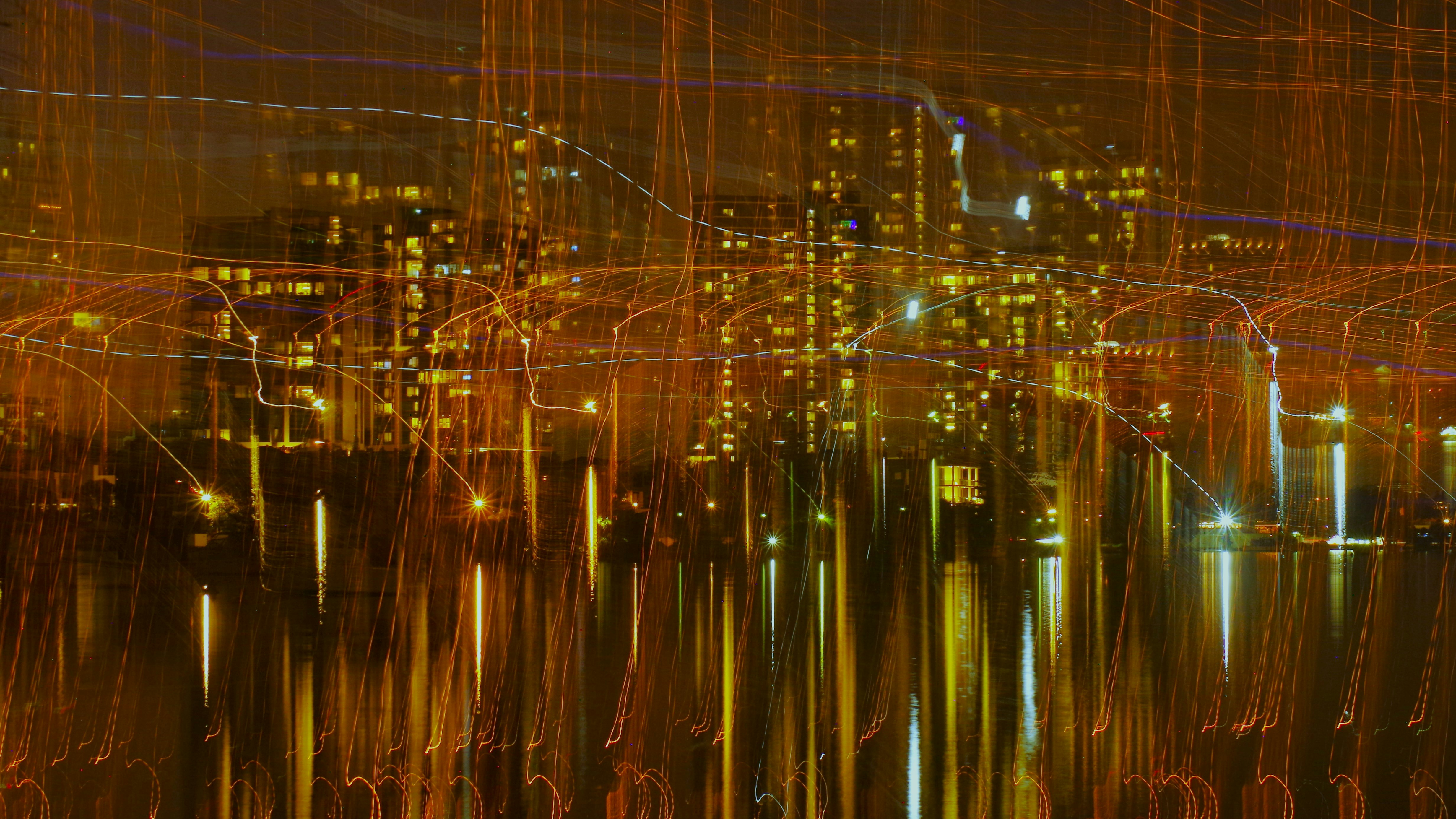 An I C M image of tower blocks overlooking the Swan River at dusk with a lot of camera movement at the end of the exposure | Long exposure photograph of city lights at night.