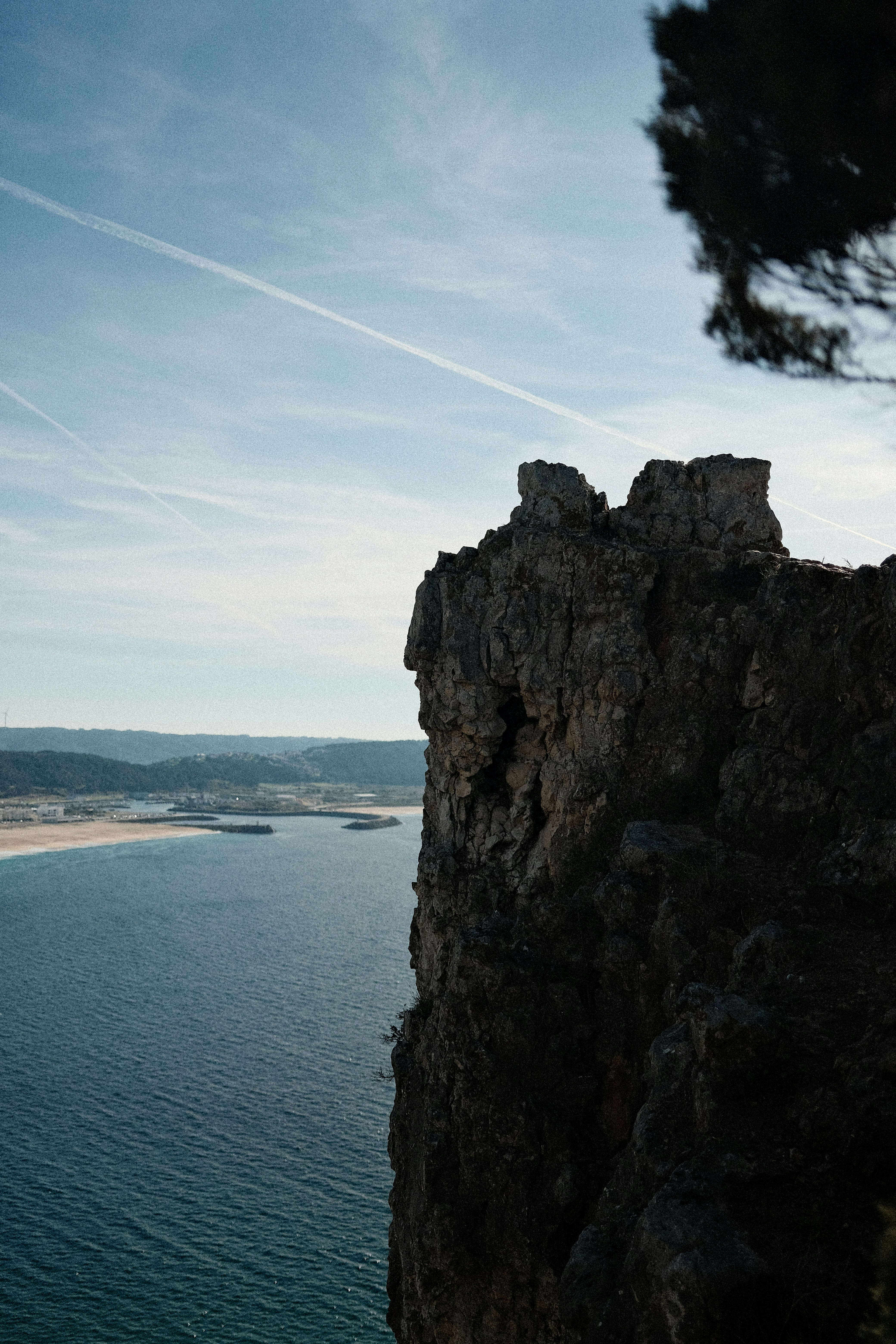 Promontory of Quiet Light: A Weathered Cliff Over a Serene Bay