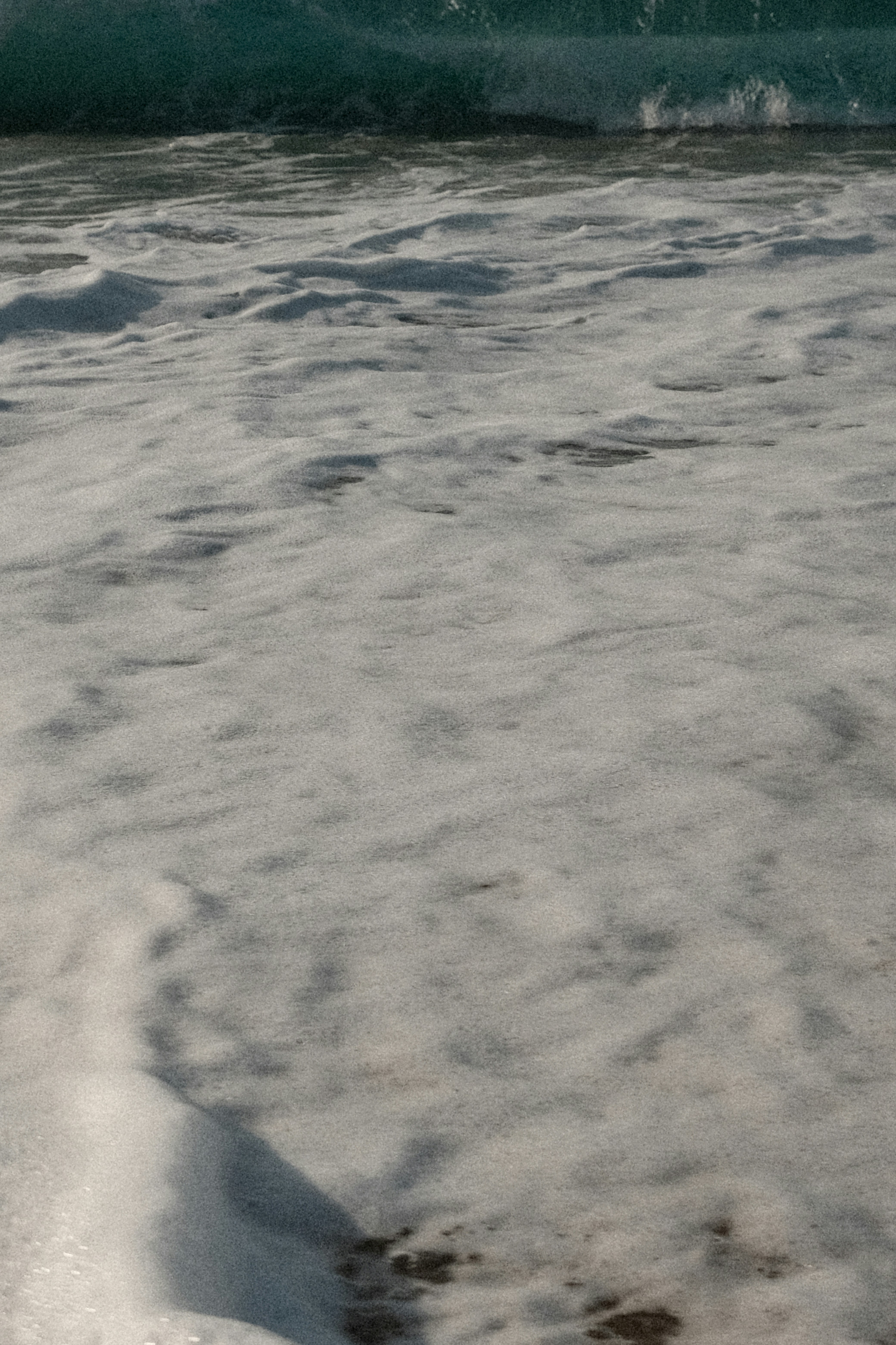Foamy ocean waves crashing on the beach.