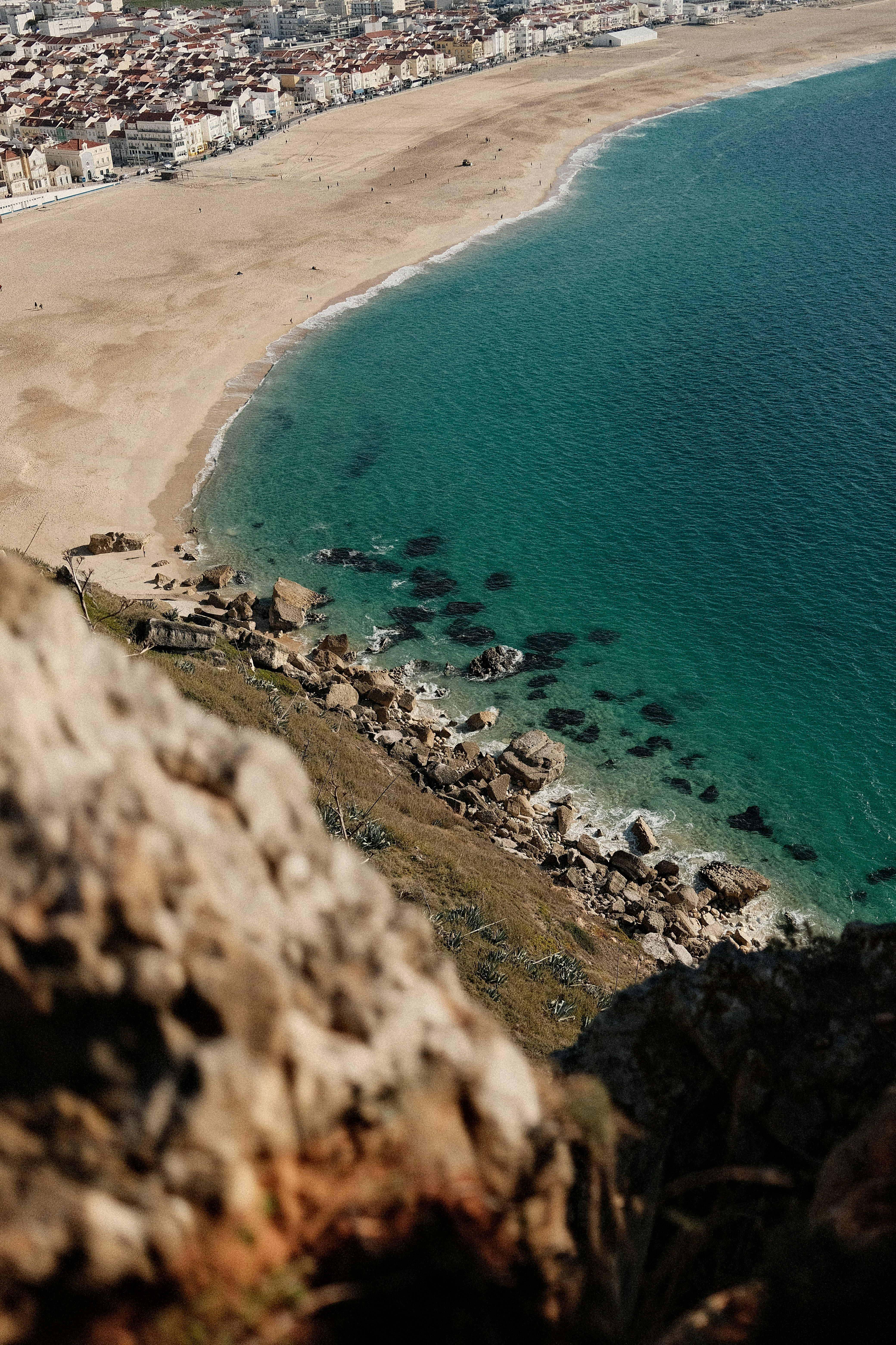 The view shows a beach and the town beside it.