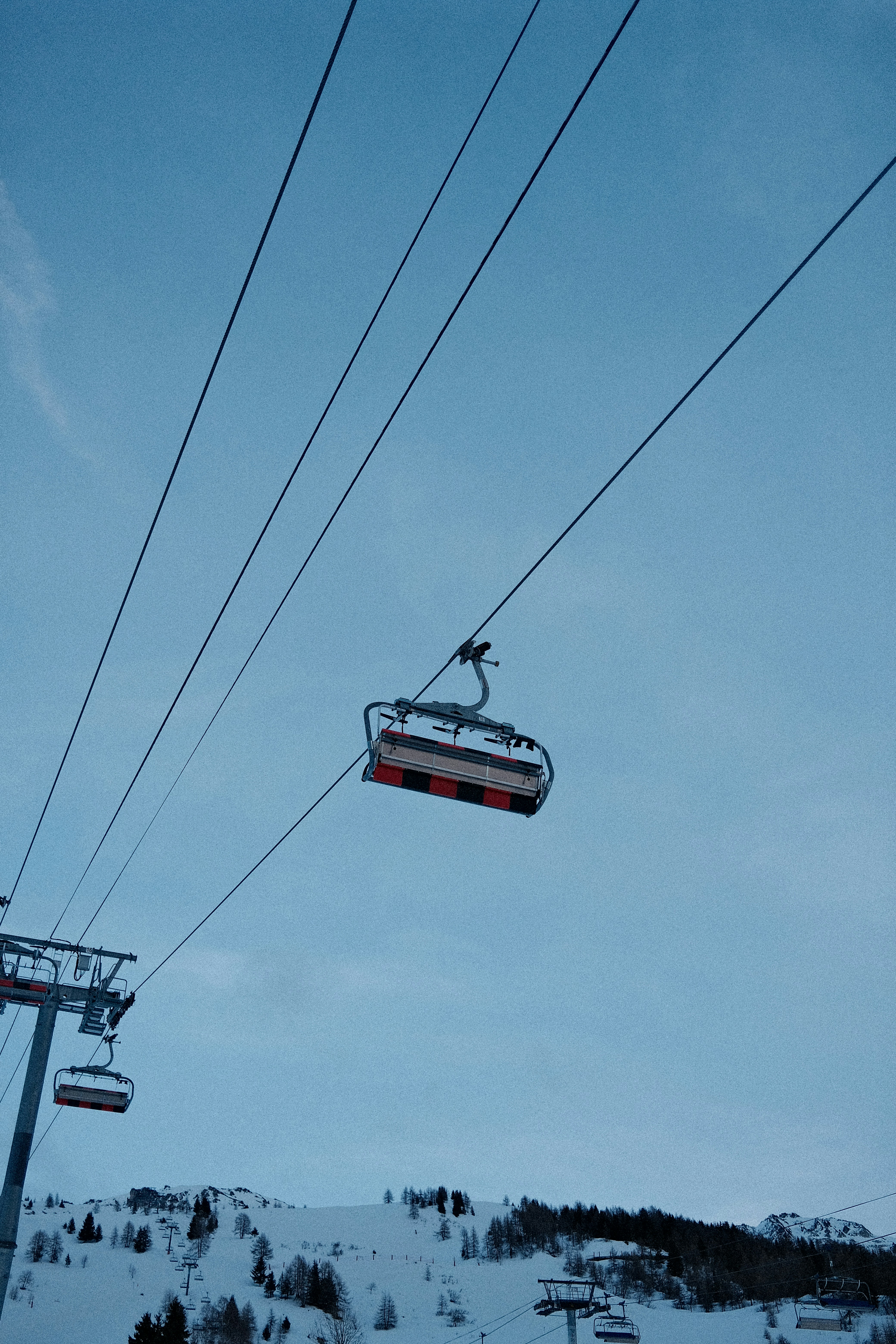 Ski lift moving across a mountain landscape.