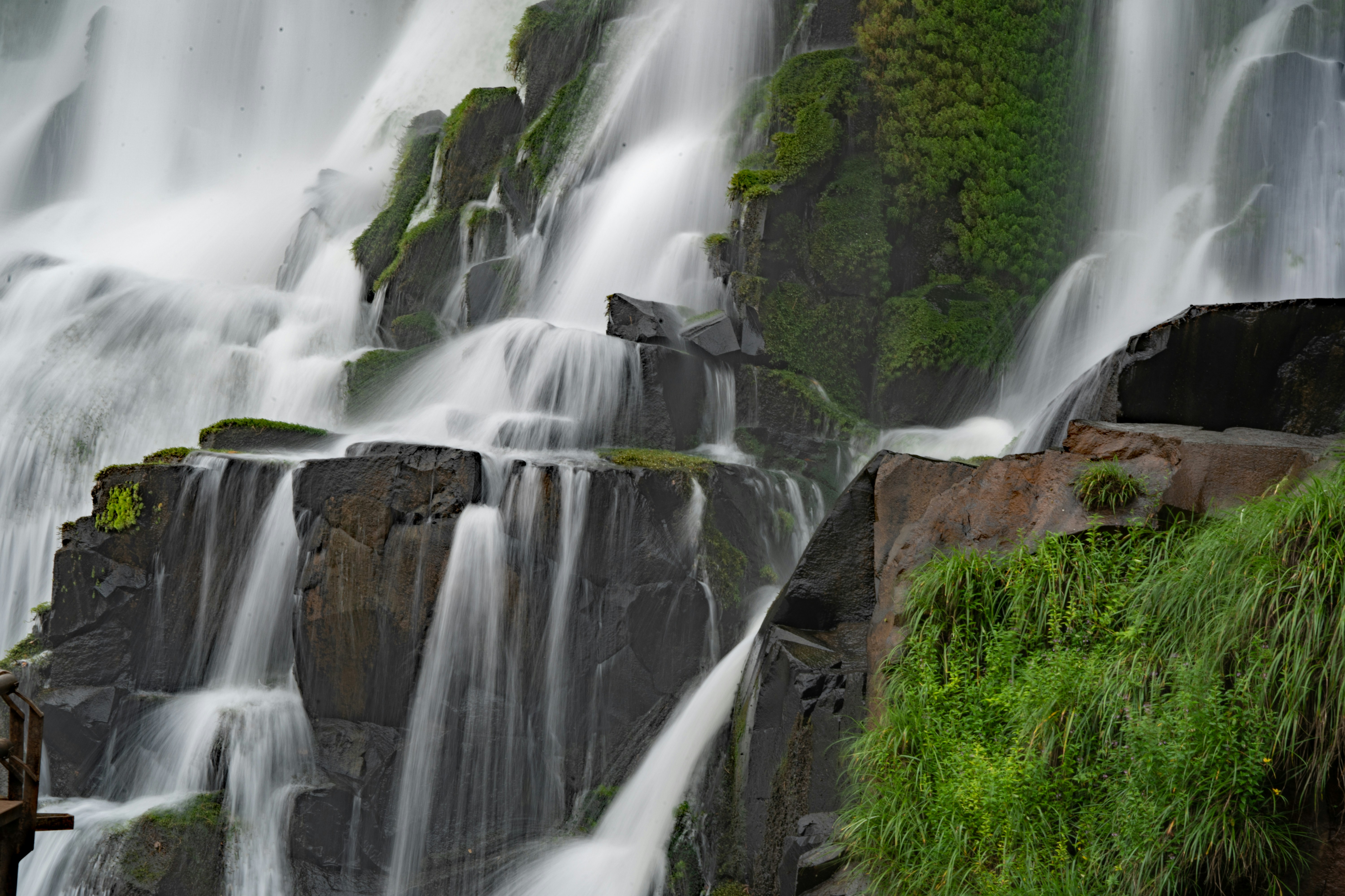 Water cascades over rocky ledges and lush greenery. photo – Free Human ...