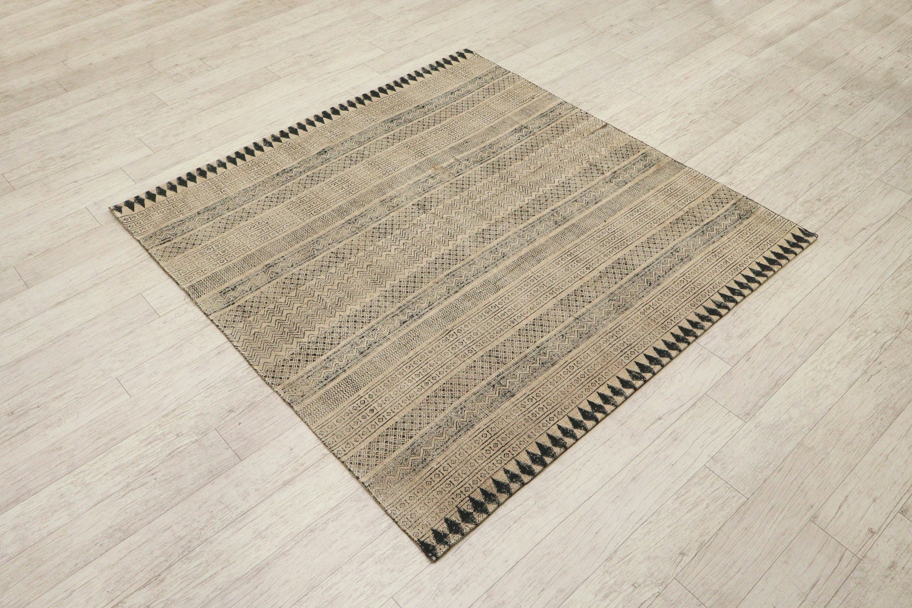 Intricately patterned area rug showcasing a blend of earthy tones and geometric designs. Ideal for enhancing interior aesthetics.