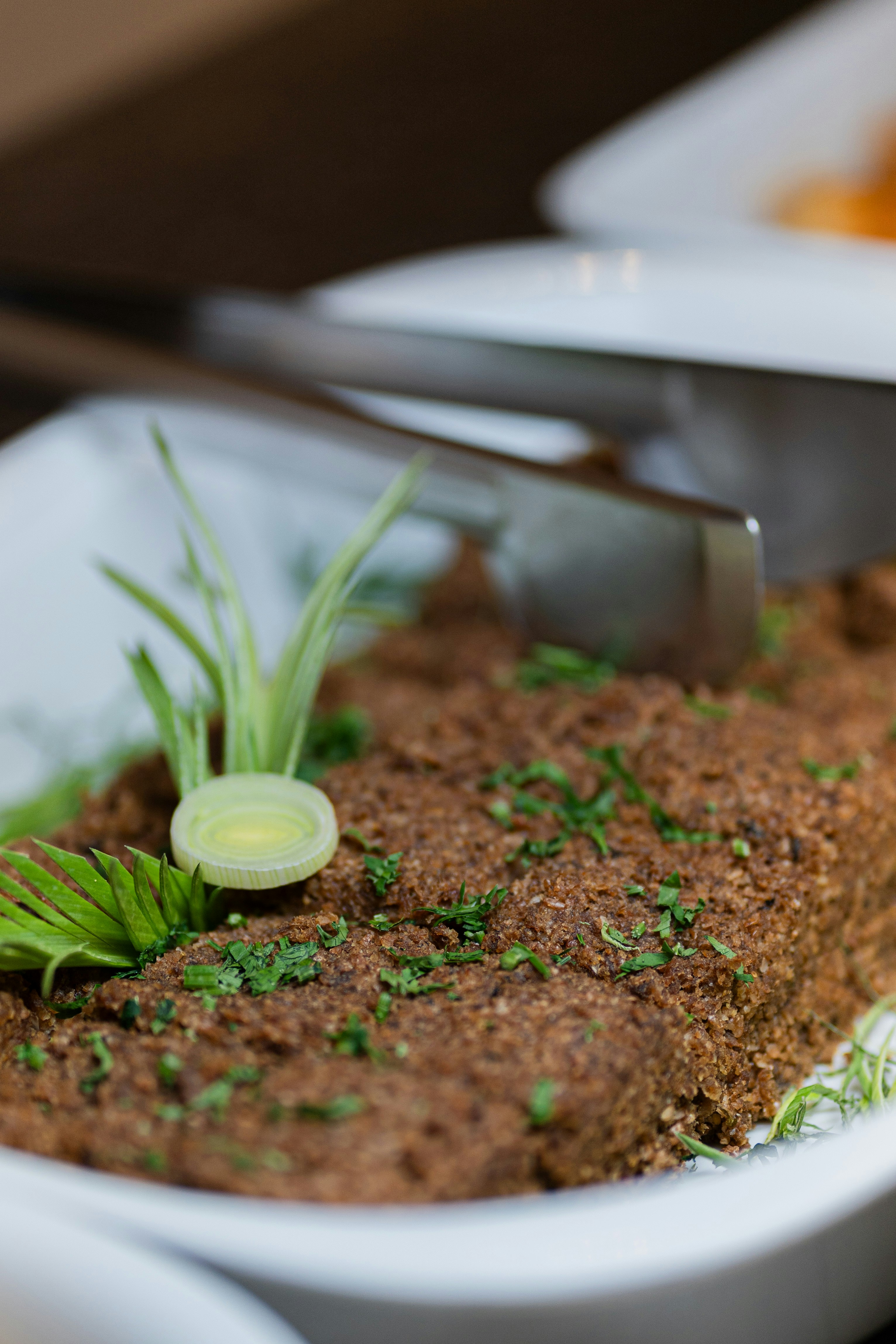 Savory Crumble Bed with Green Garnish and Sliced Leek