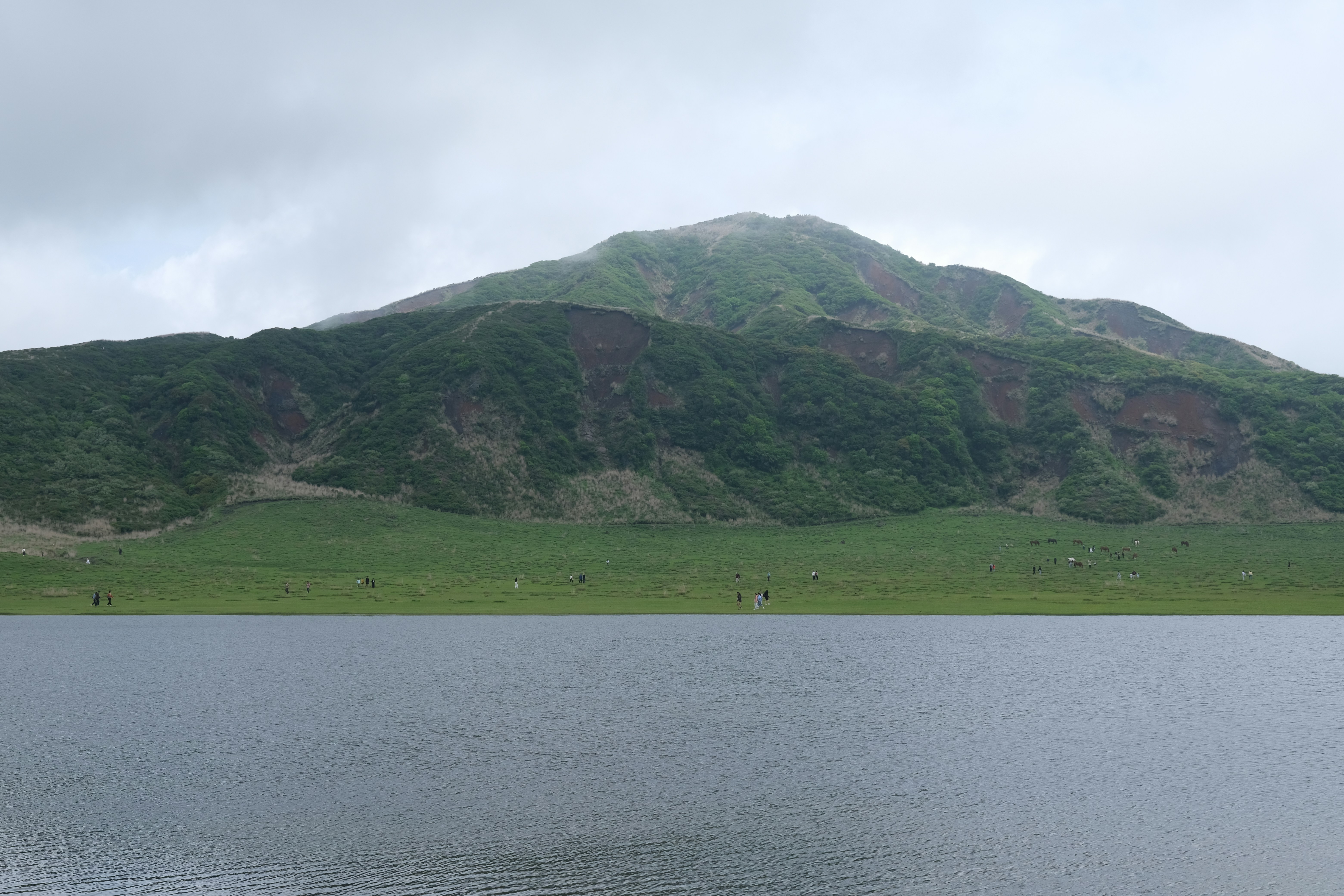 Verdant Crest over a Quiet Lake