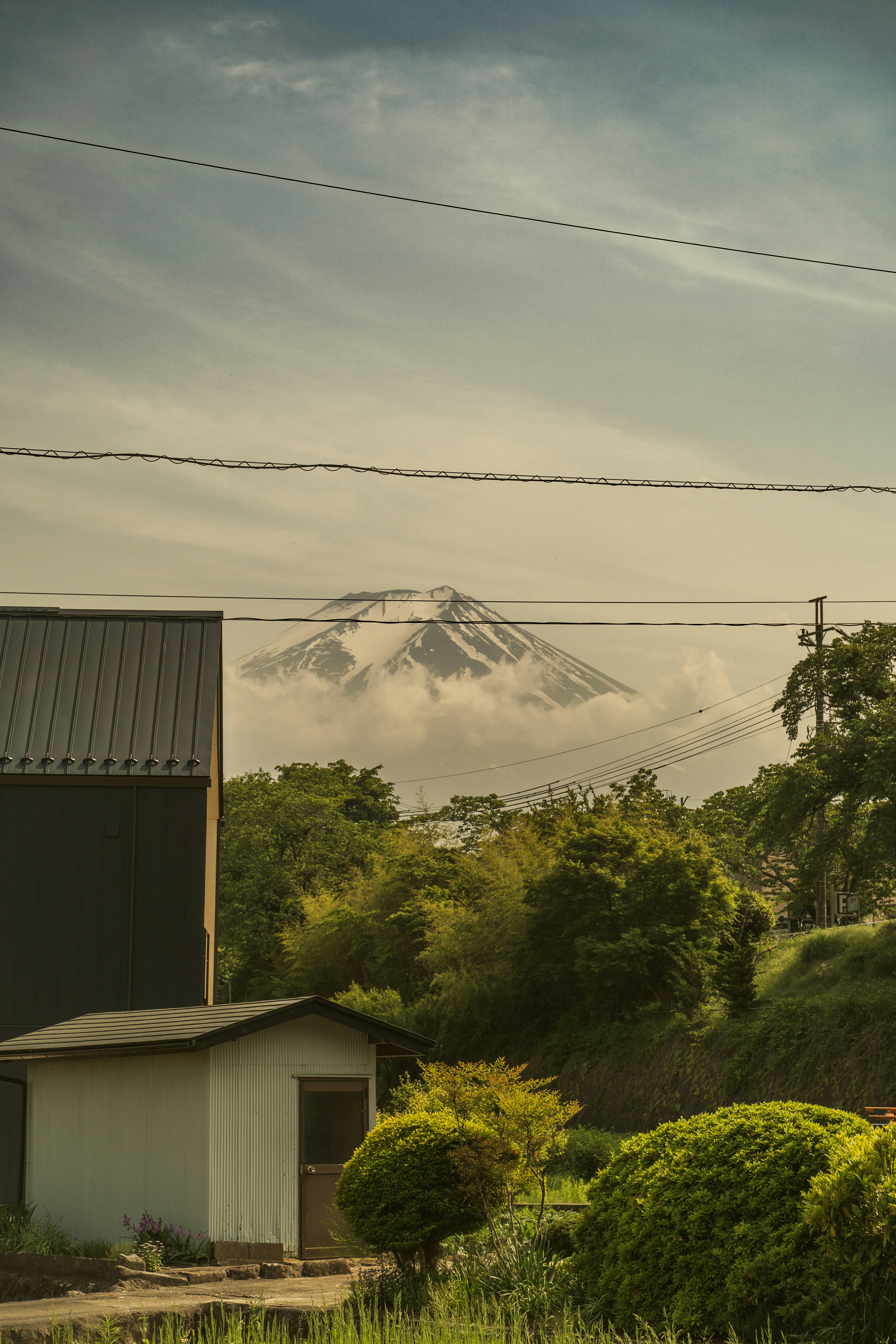 A snowy mountain peaks out from the clouds.