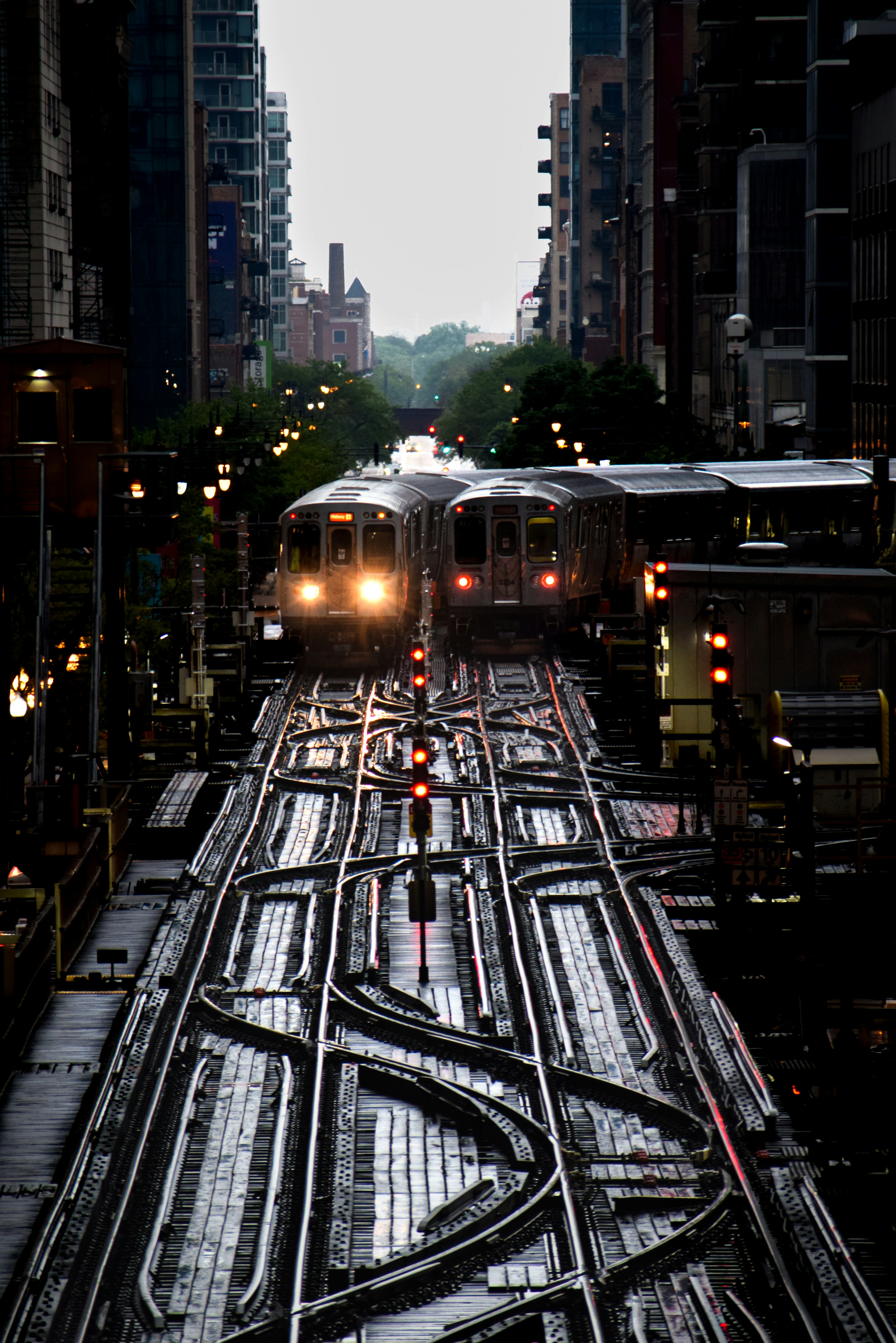 Midnight Convergence: Two Trains Crossing a Web of Wet City Rails