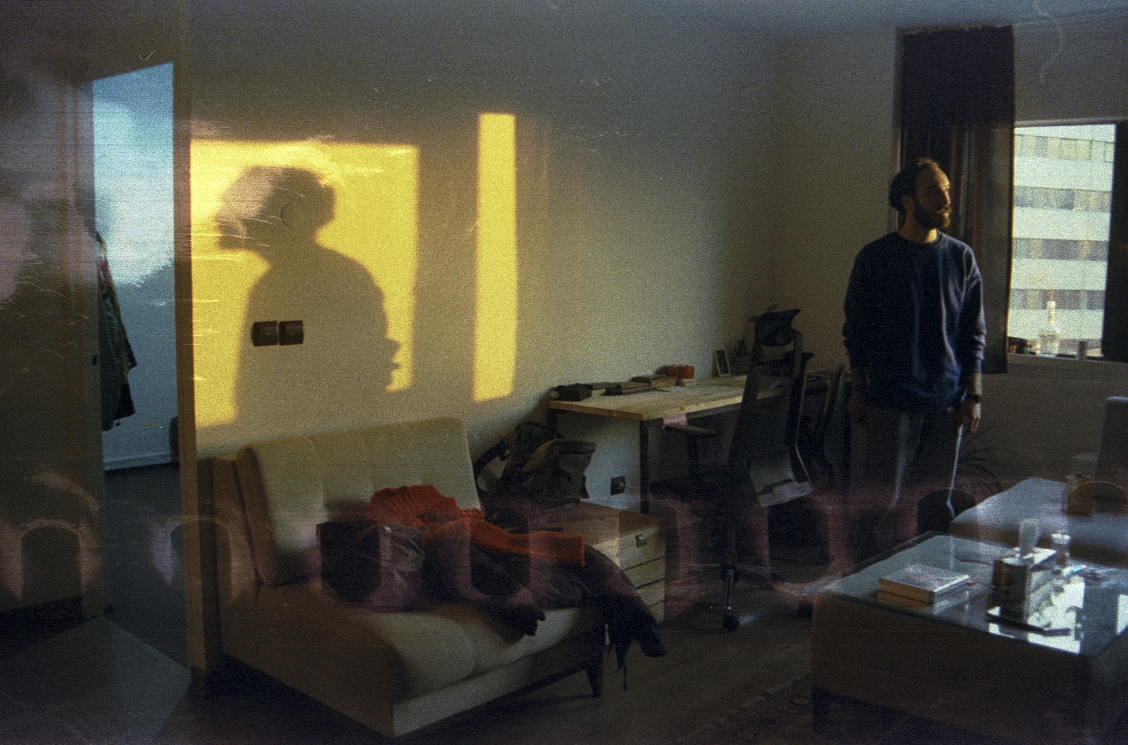 Loft Echoes: A Yellow Shadow Portrait in Reflection
