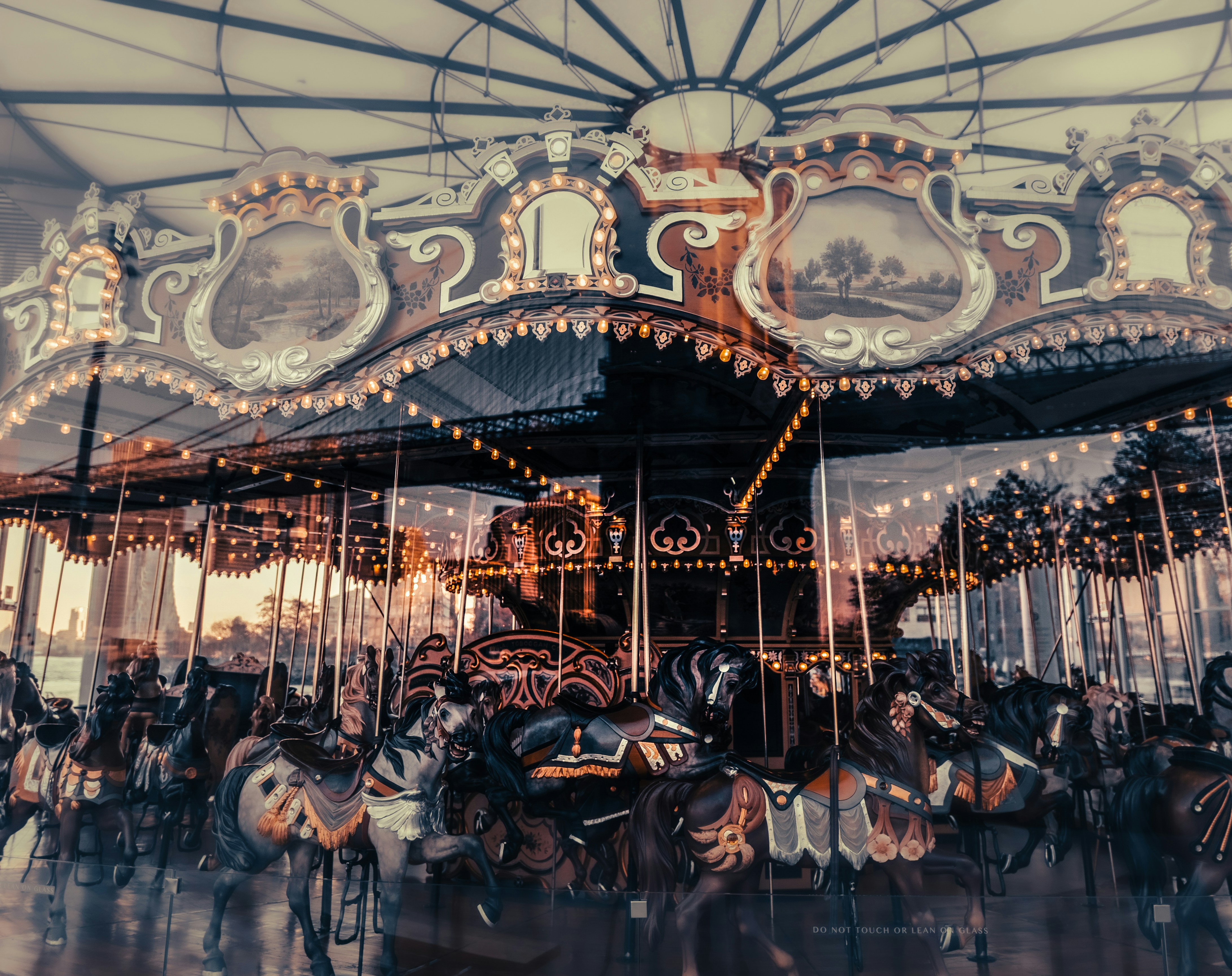 Jane's Carousel in Brooklyn Bridge Park | A vintage carousel illuminated by warm lights.