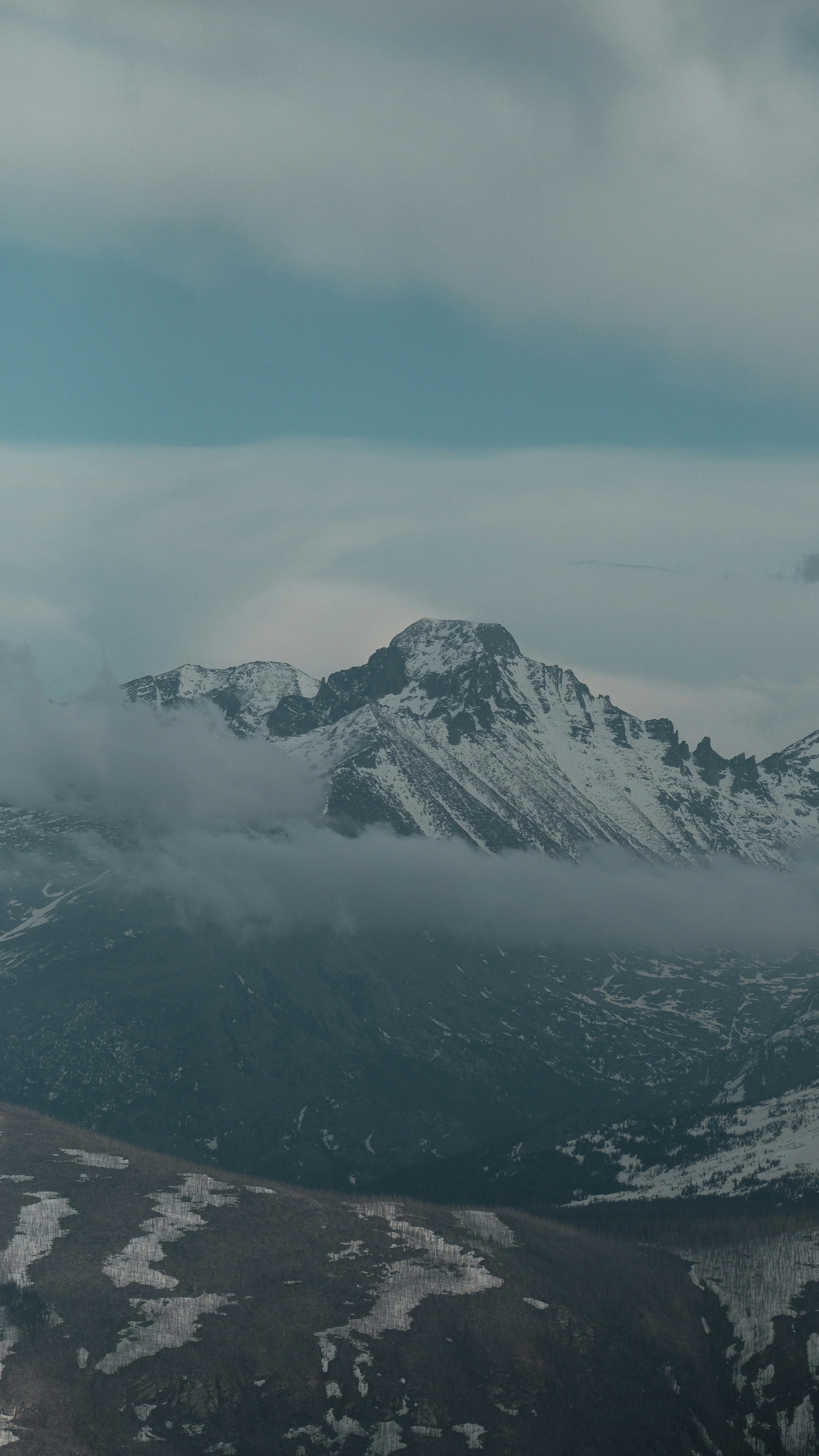 Snow-capped mountains pierce the cloudy sky. photo – Free Cloud Image ...