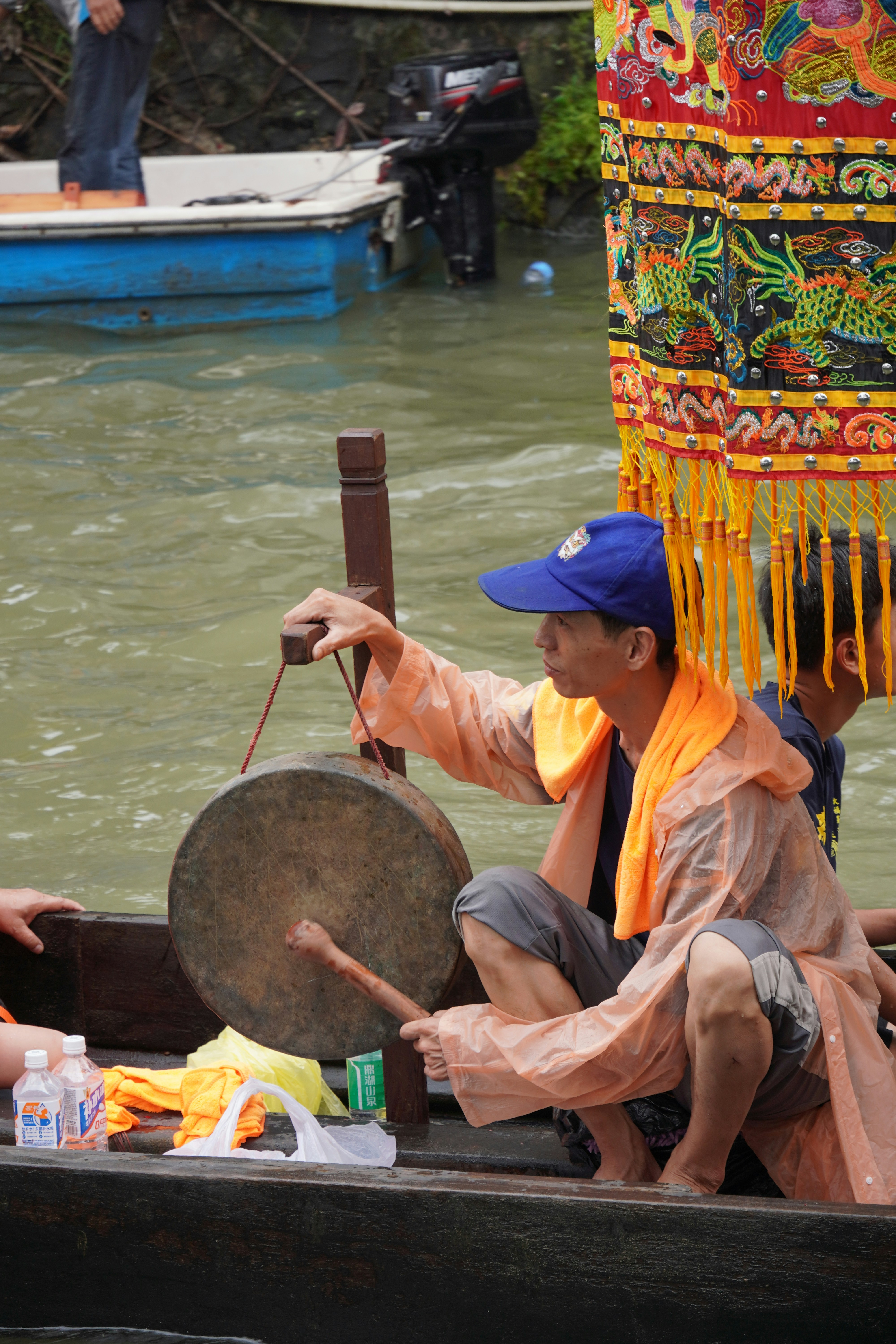 Gong Drummer by a Dragon-embroidered Banner on a River Vessel