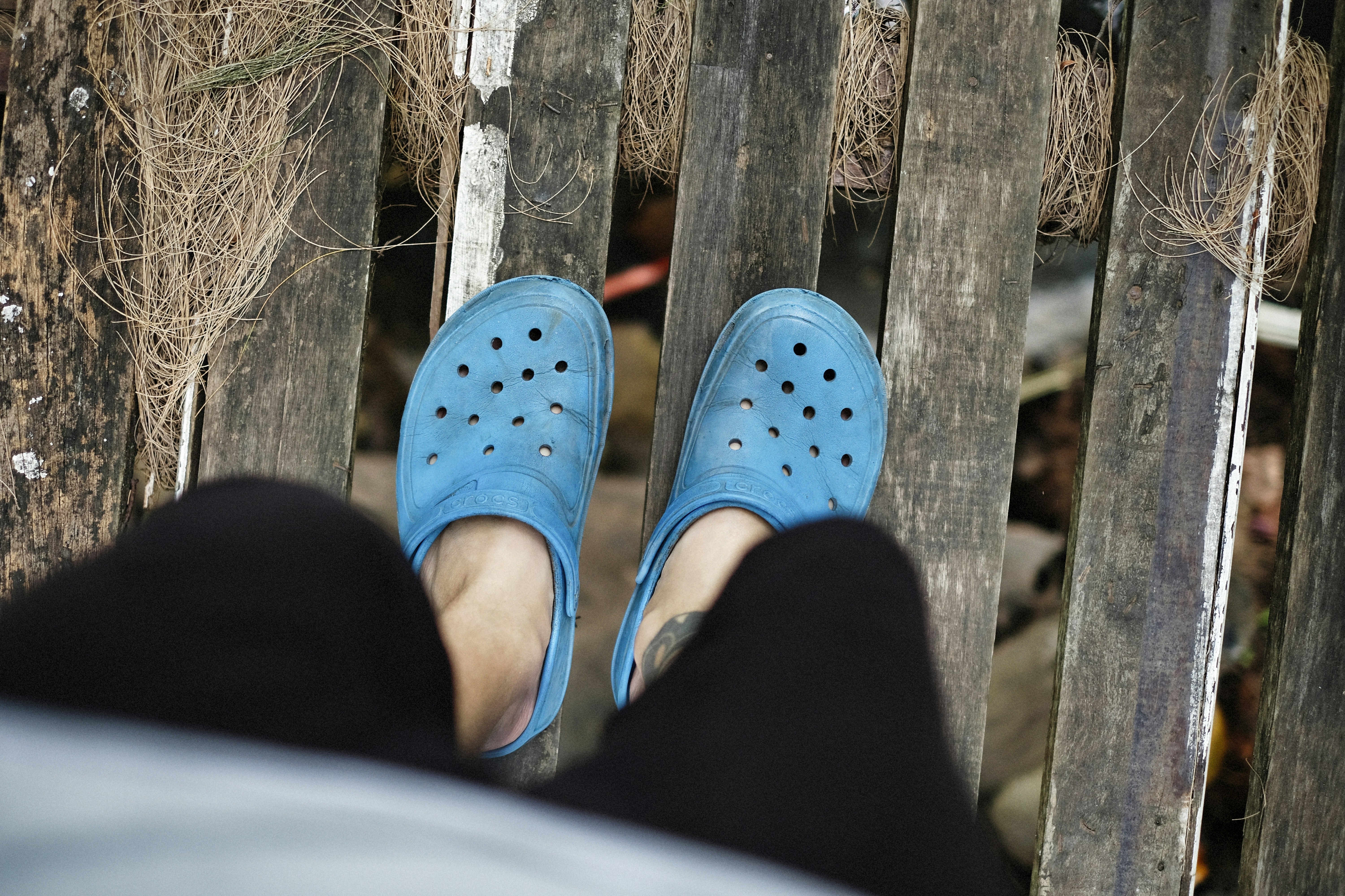 Blue Slip-Ons on a Narrow Plank: A Suspended Perspective