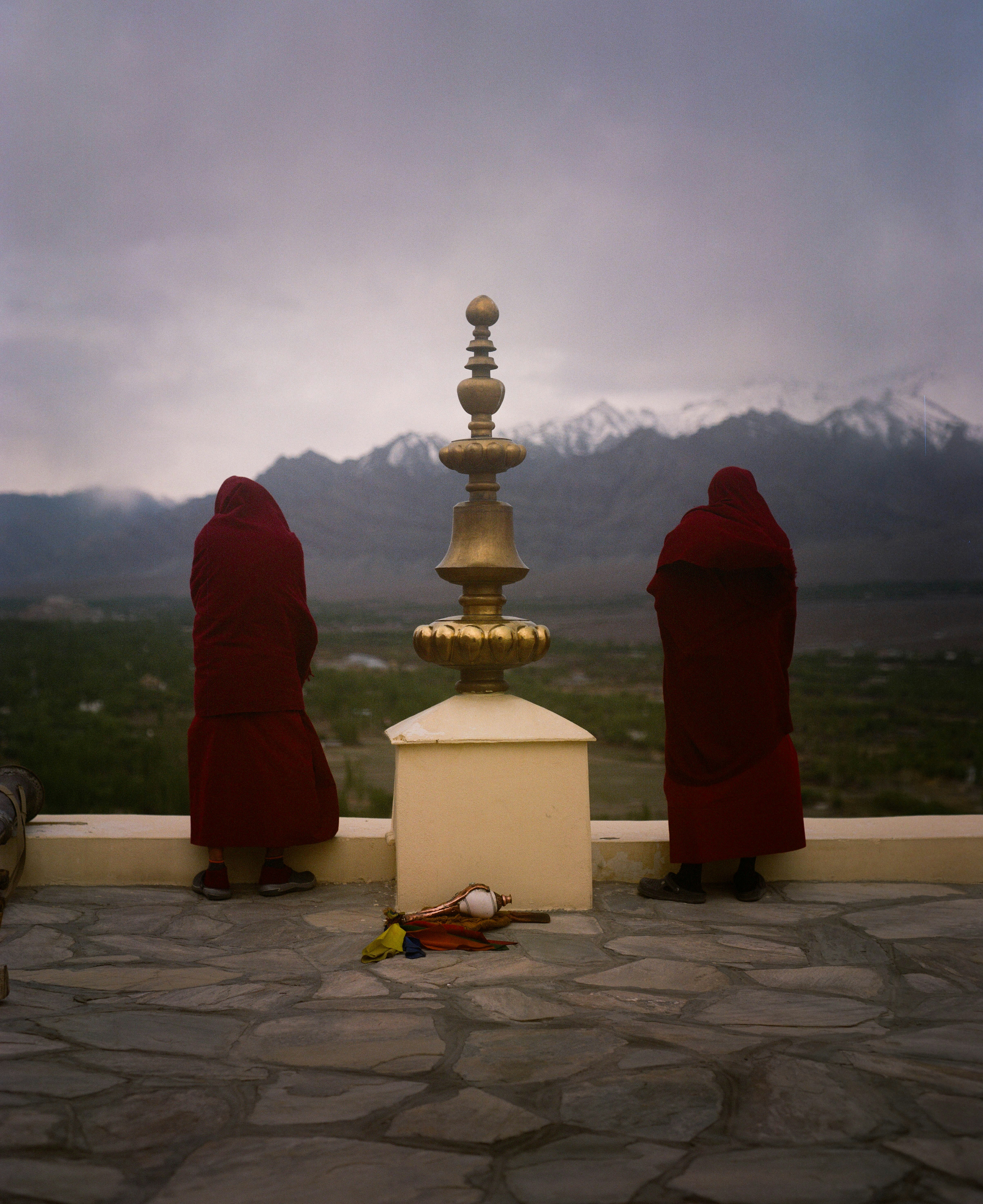 Two monks contemplate nature beneath a mountain. photo – Free Travel ...