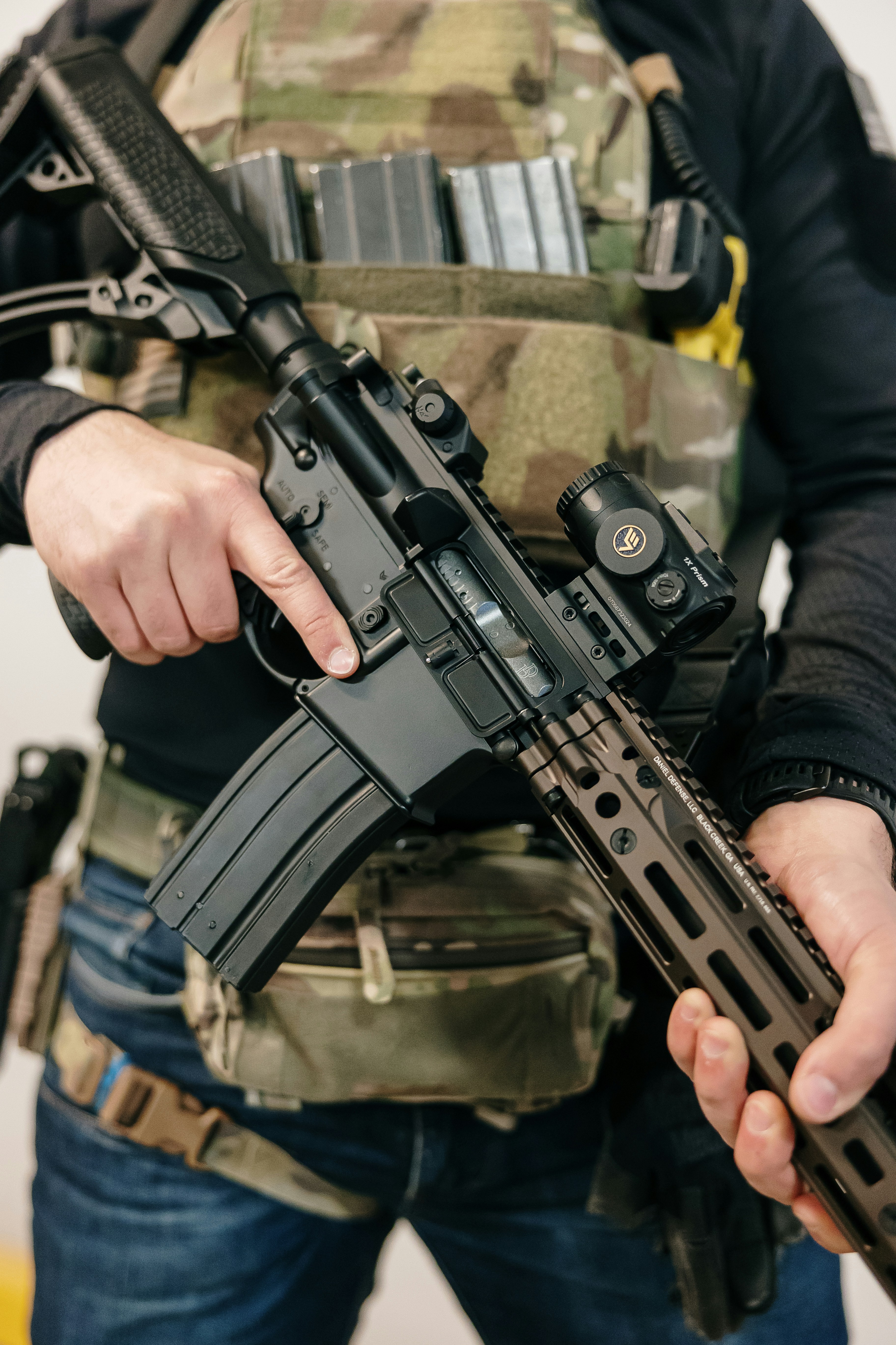 A person holds a rifle with tactical gear. photo – Free Tactical Image ...