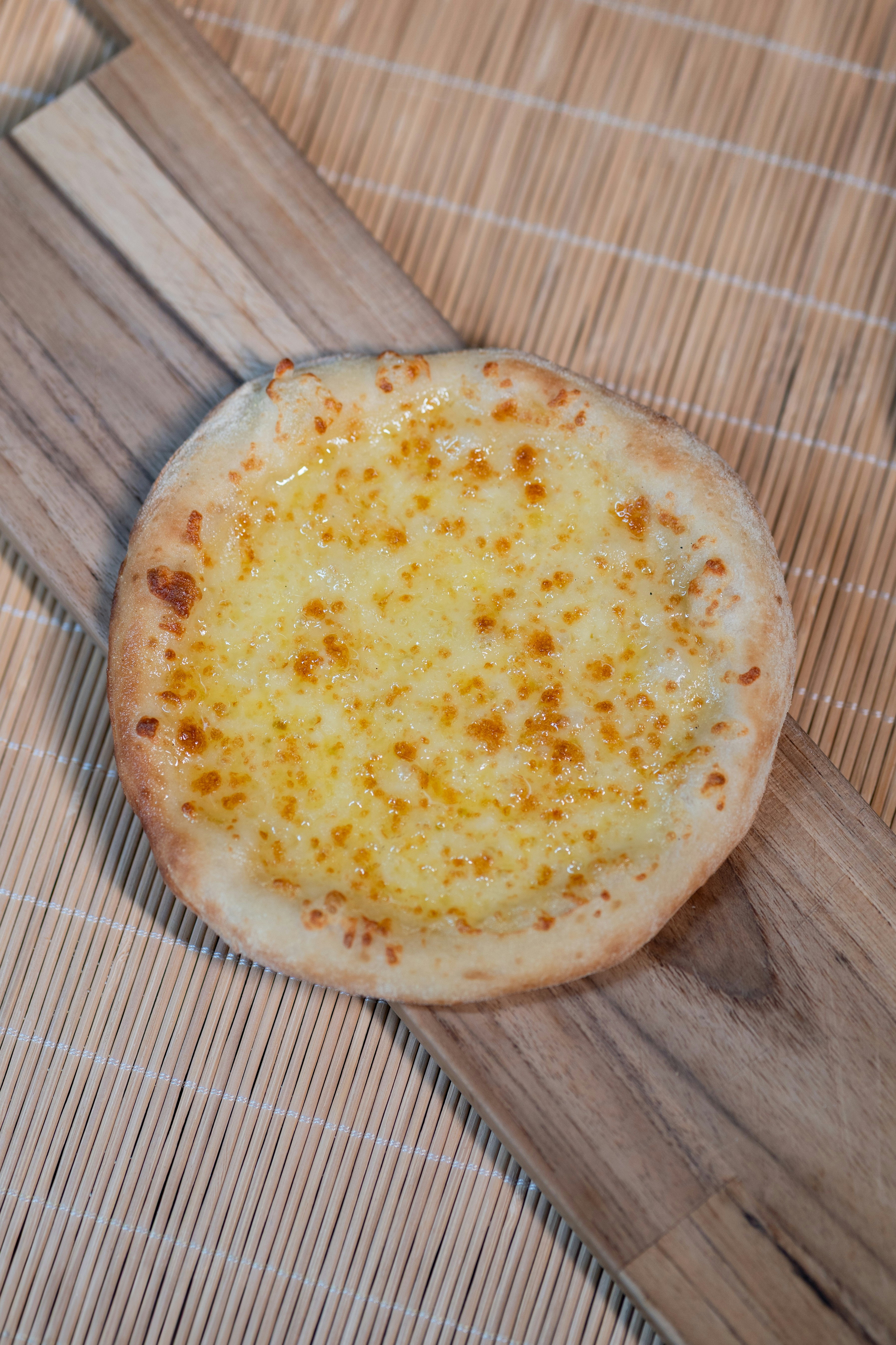 Cheese bread is served on a wooden board.