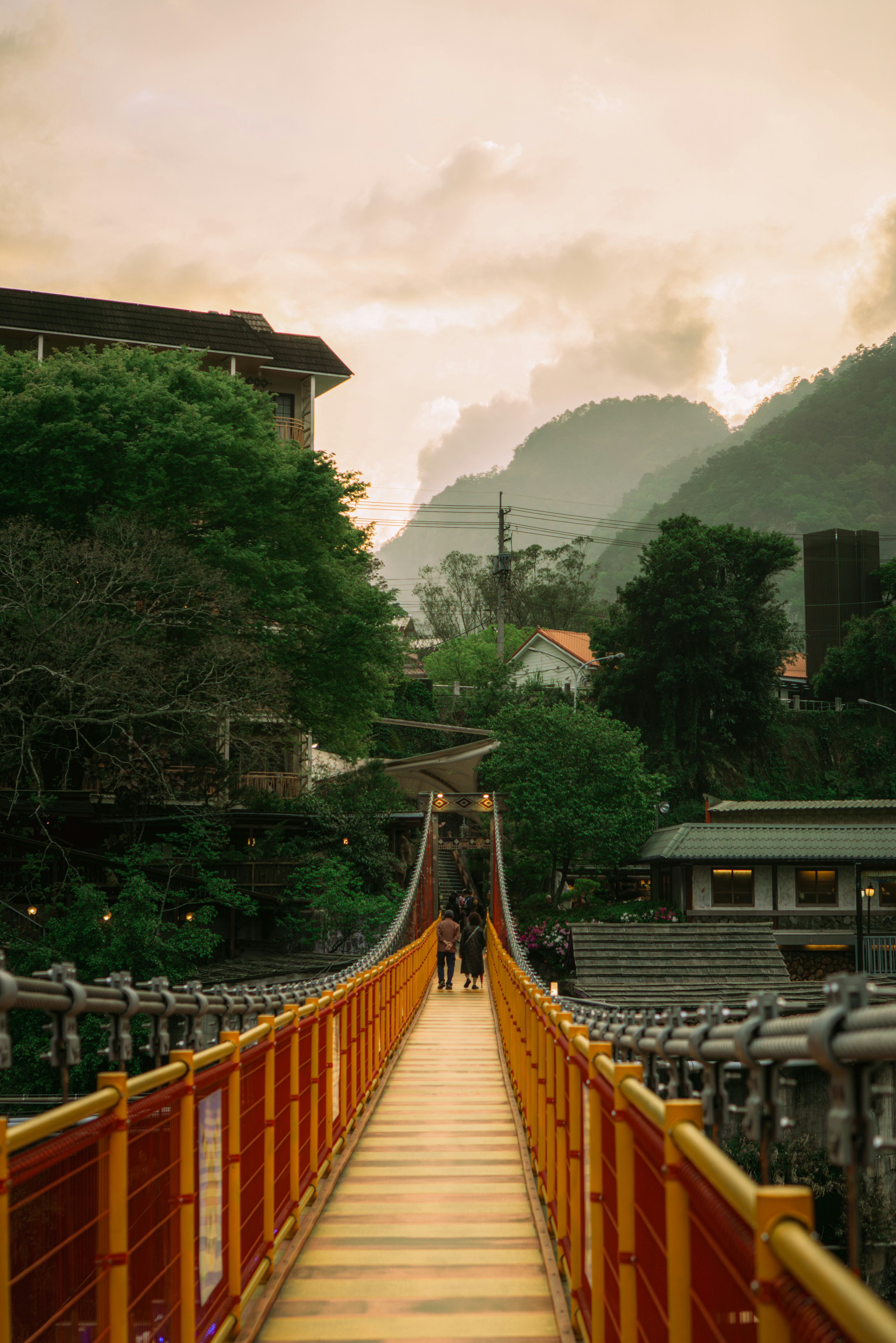 Suspended Across the River: A Golden Walkway into Quiet Hills