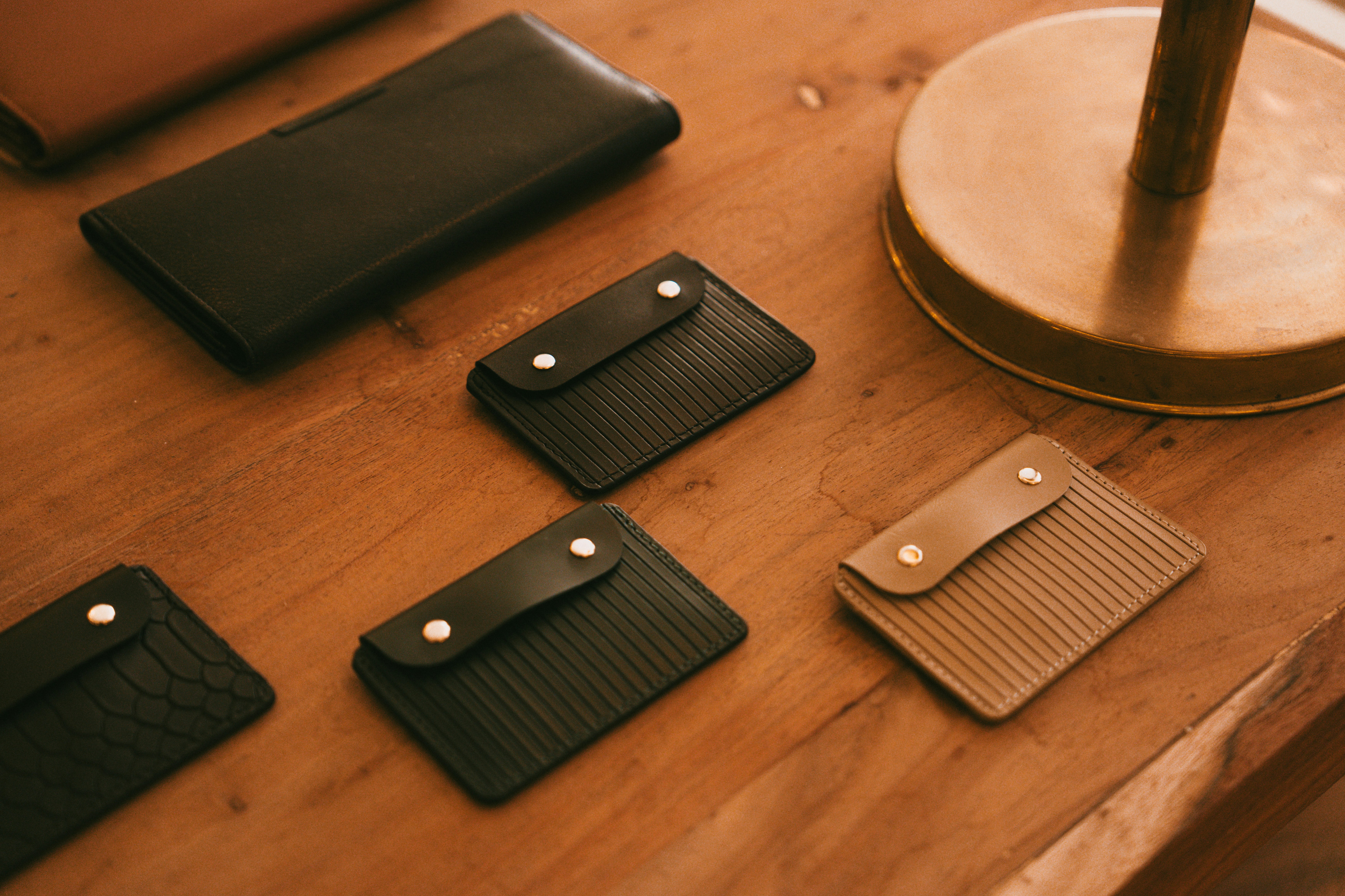 Leather wallets and cardholders sit on a table. photo – Free Product ...