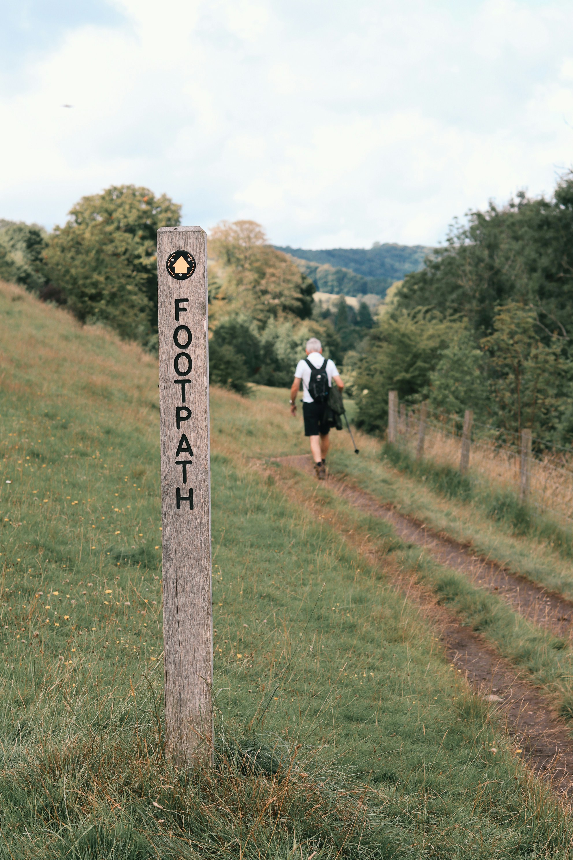 A person walks on a scenic footpath.