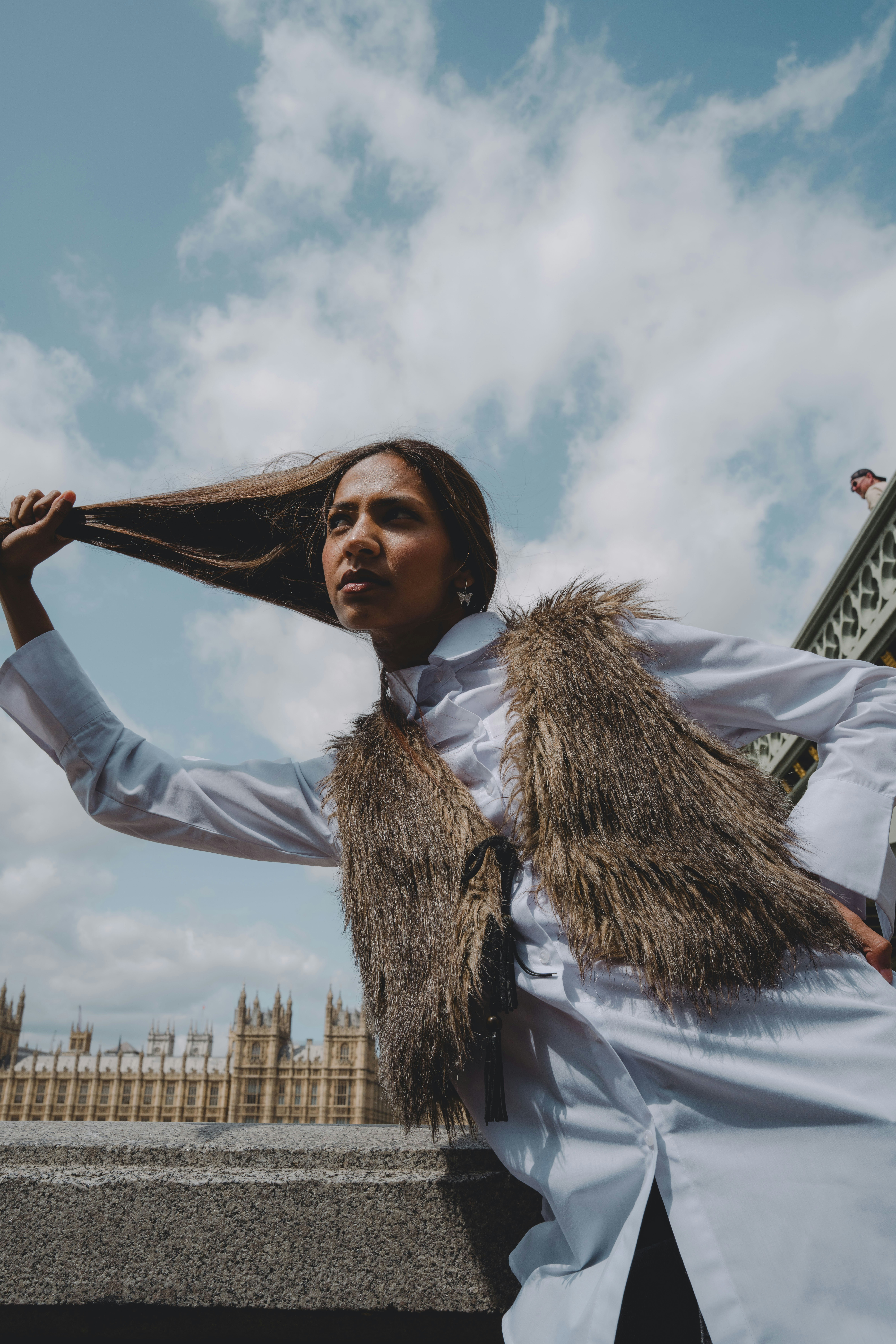 Woman in a faux fur vest poses outdoors. photo – Free Fashion Image on ...