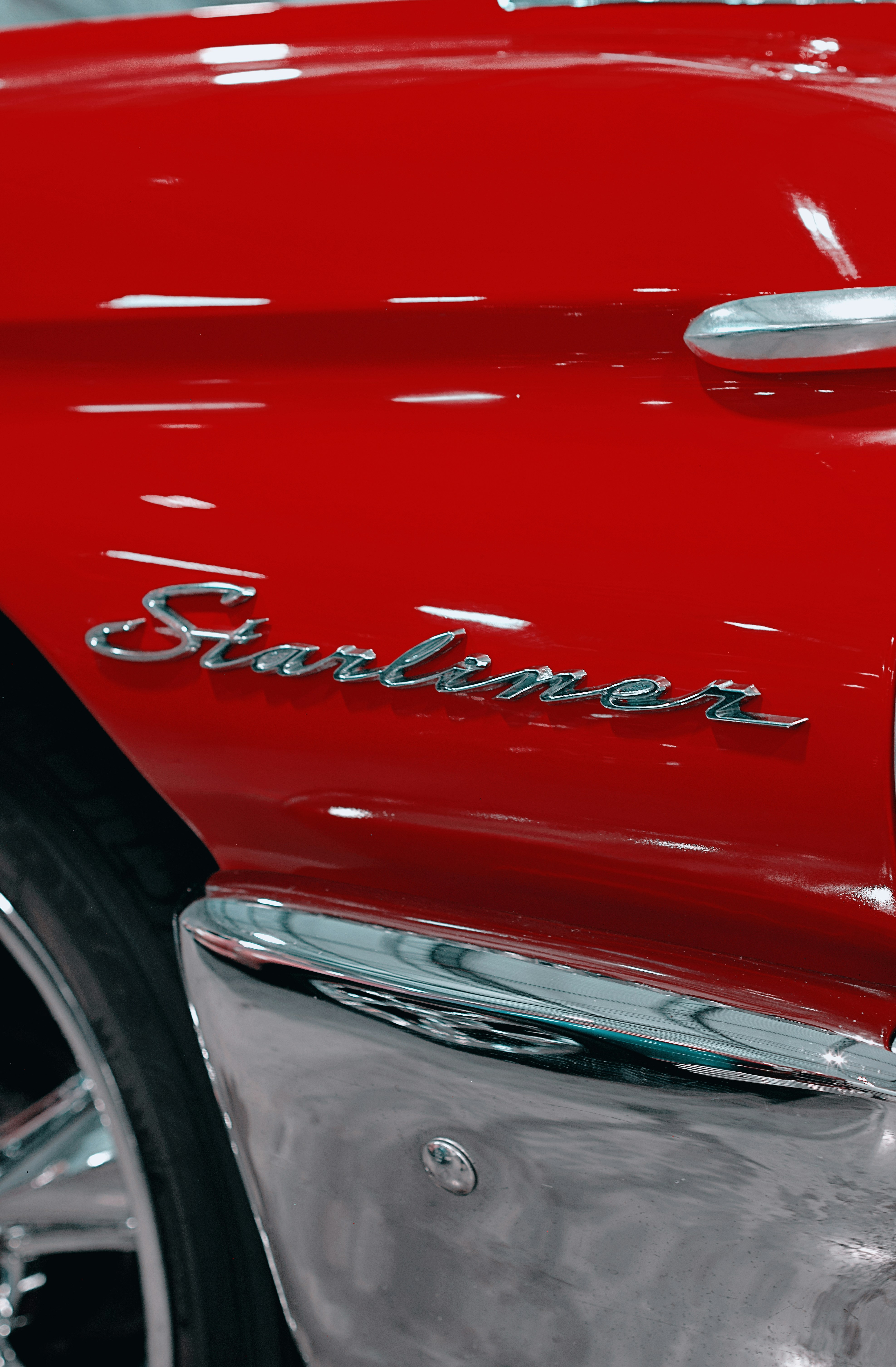 A red ford starliner's chrome emblem is visible. photo – Free Car Image ...
