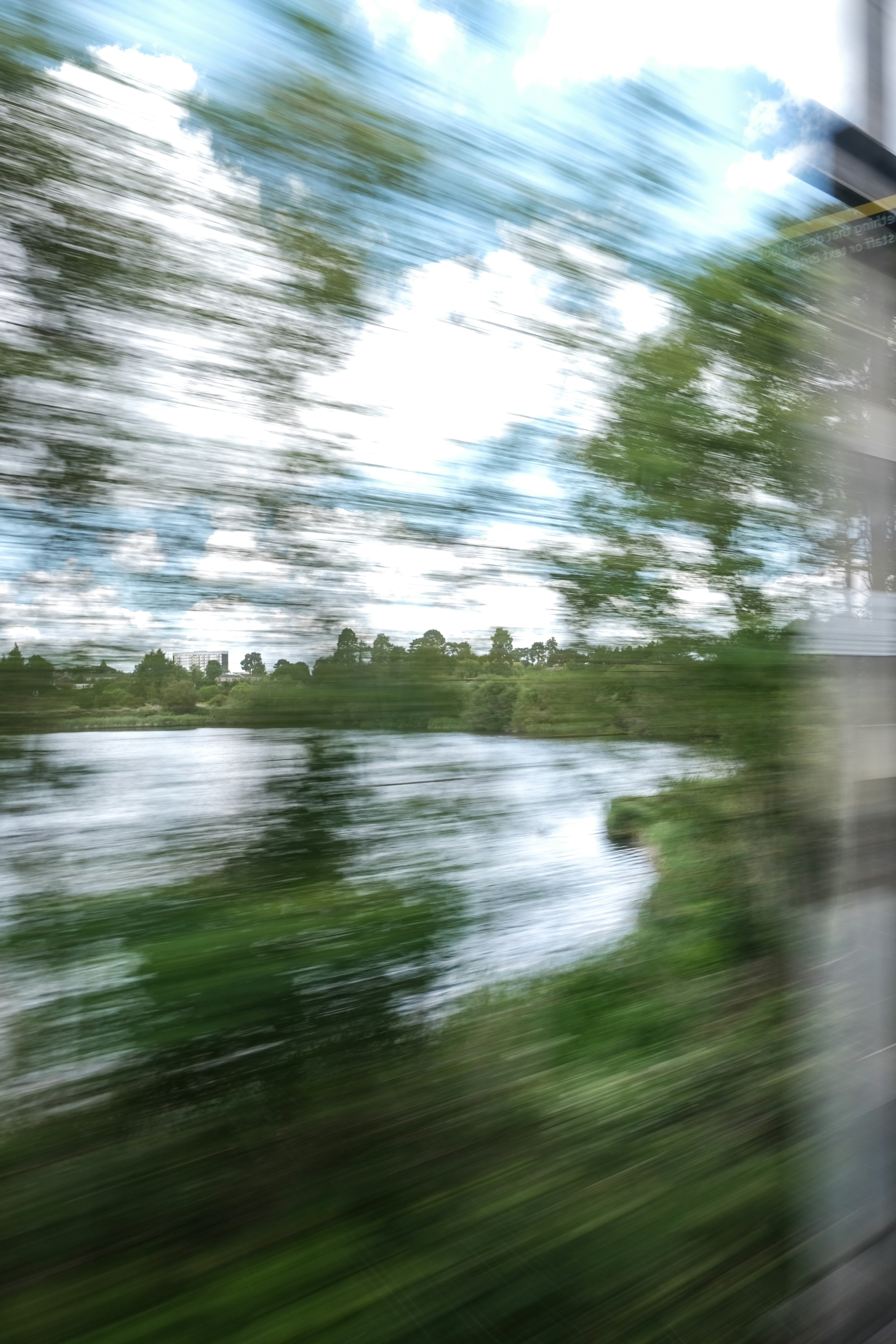 Blurred view of a lake and trees from a moving vehicle. photo – Free ...