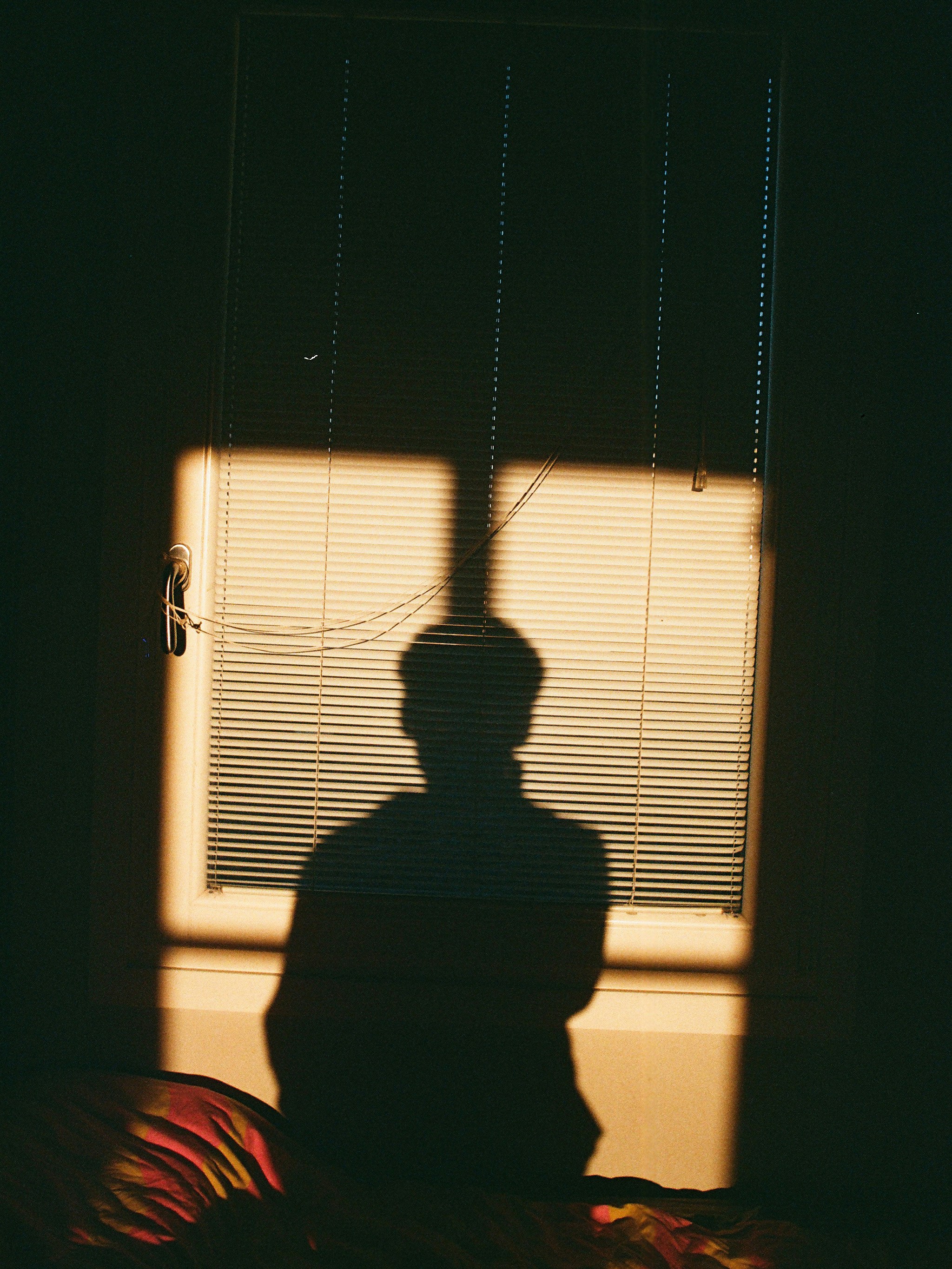 A shadow cast by a figure near a window. photo – Free Film Image on ...