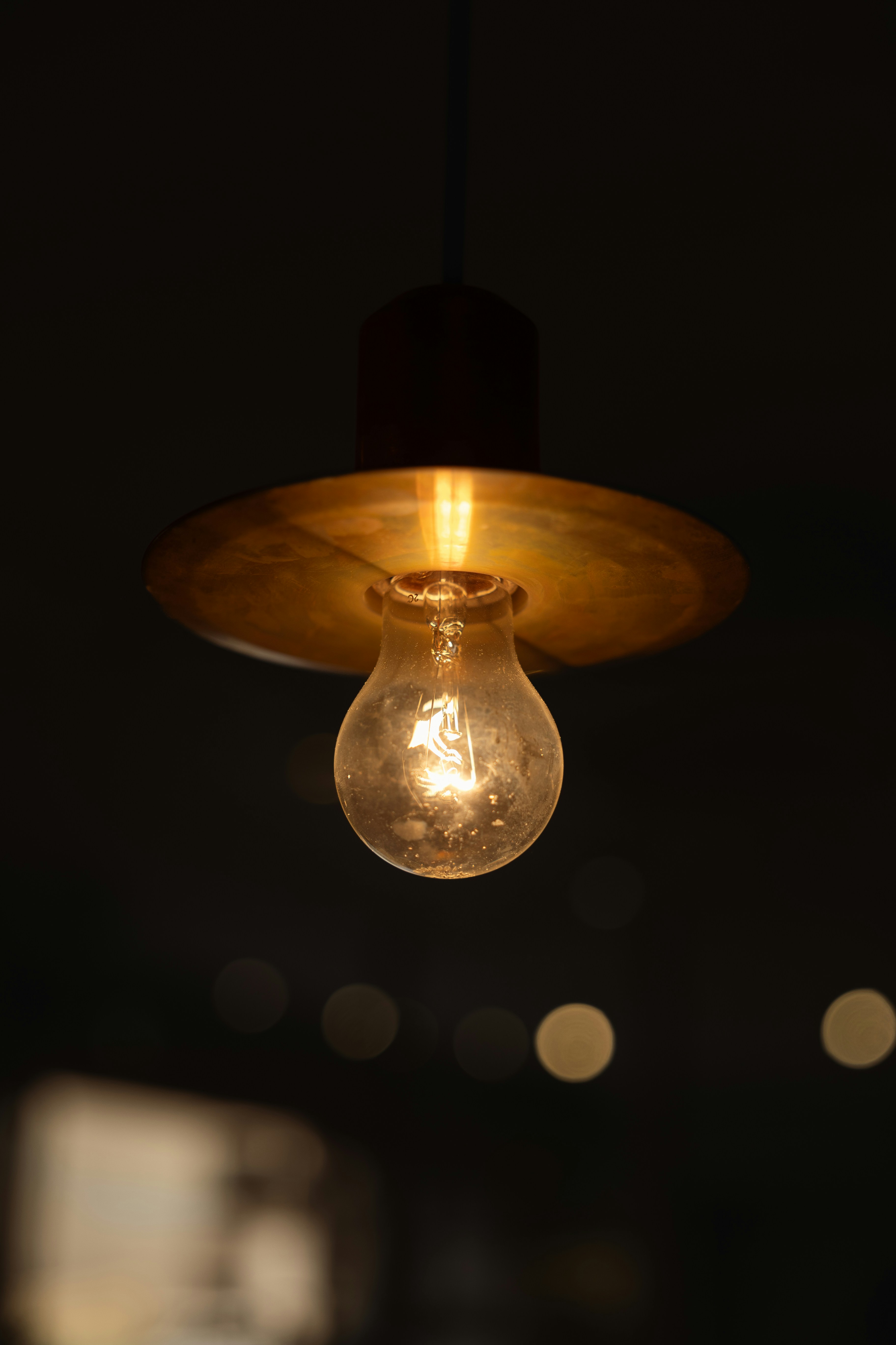 A light bulb glows against a dark background. photo – Free Light Image ...