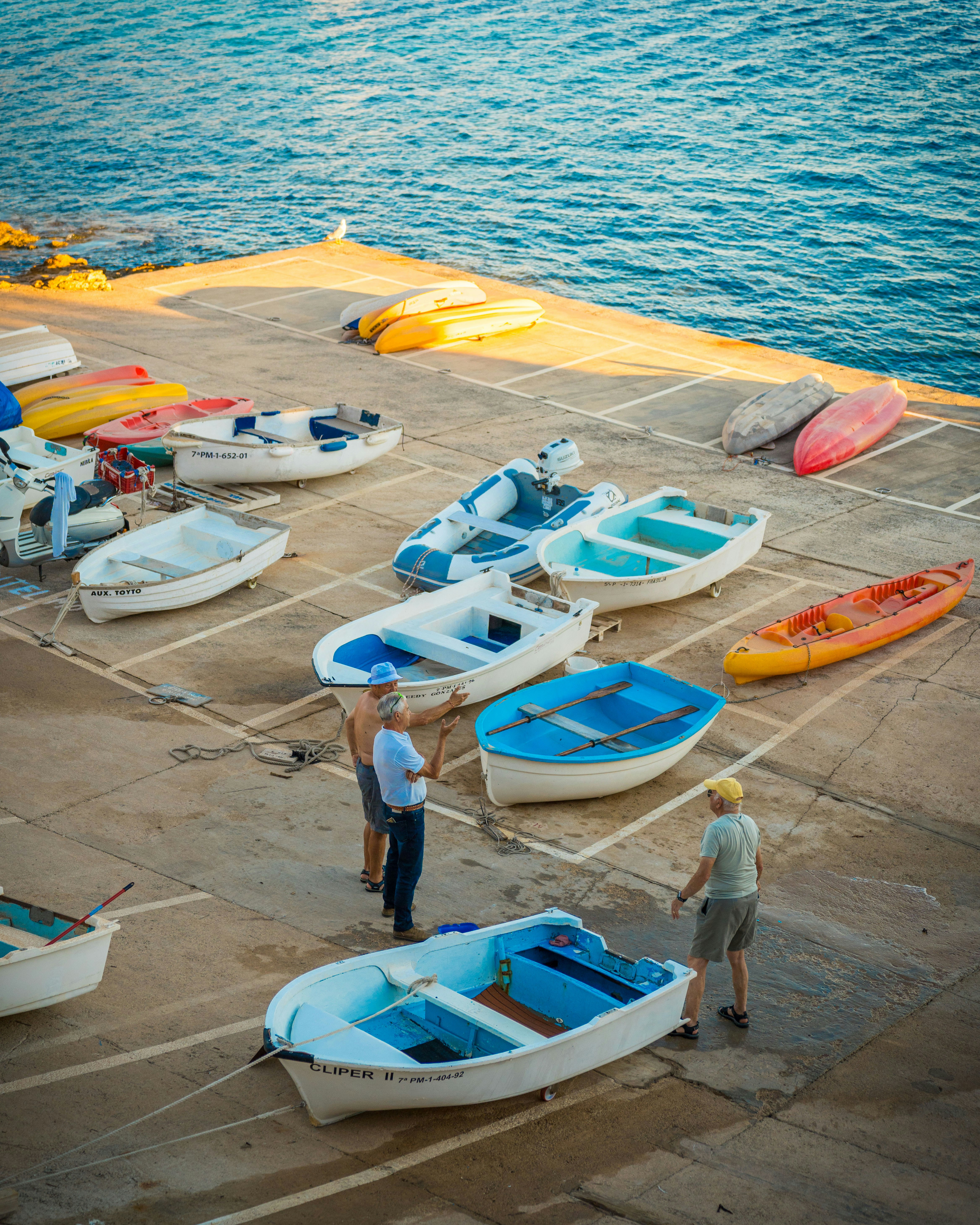 Dockside Dialogue: Conversations Amid Colorful Dinghies