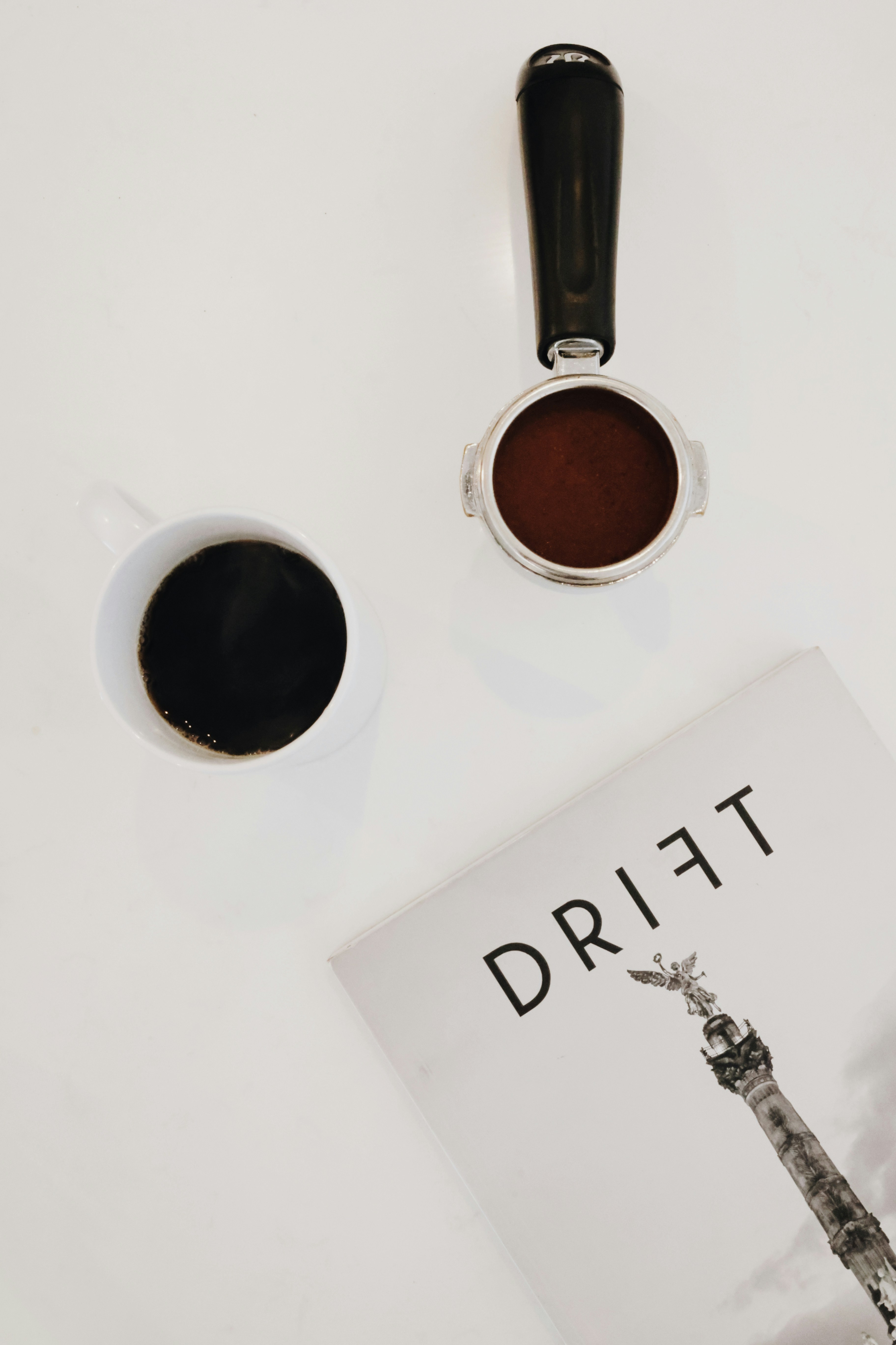 Coffee, filter, and magazine lay out on a white surface. photo – Free ...