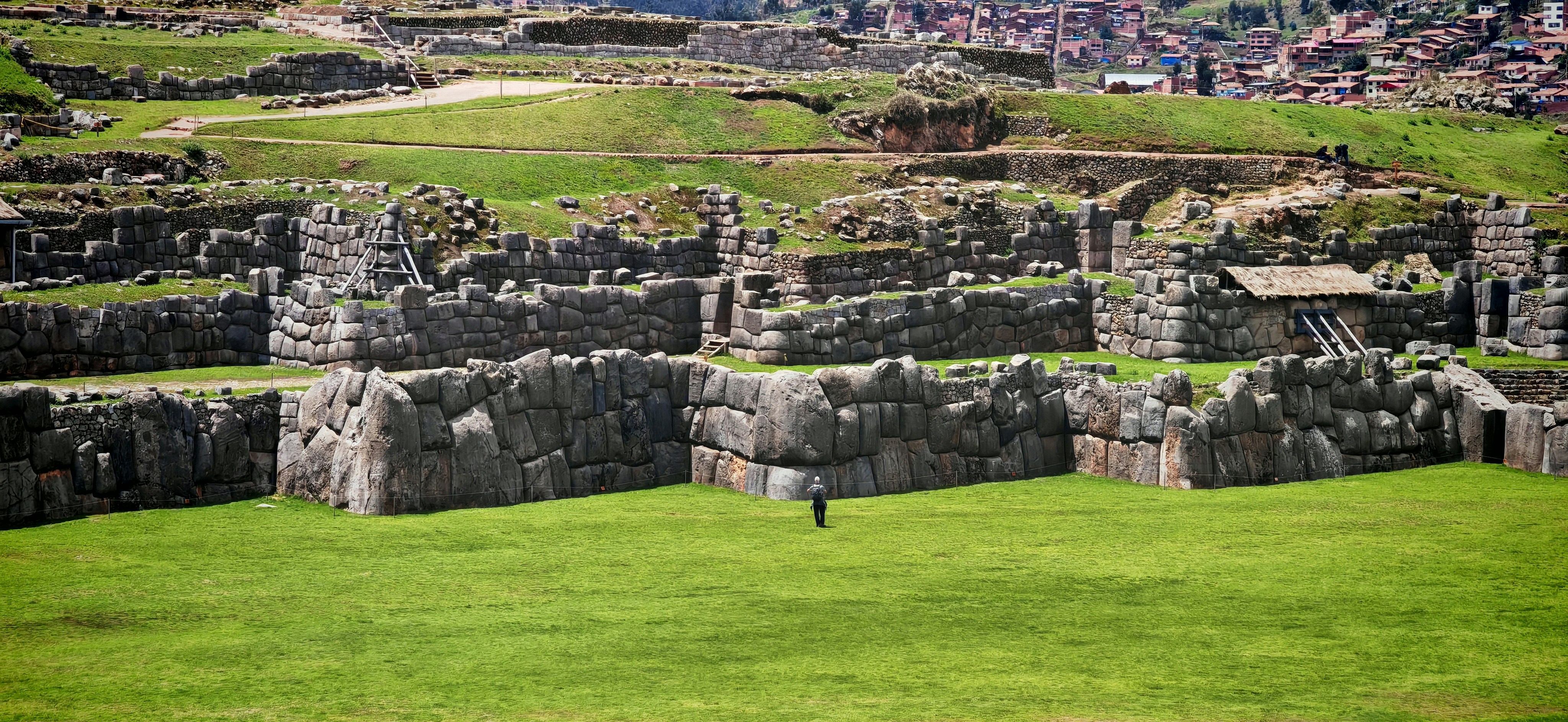 Stone ruins in a grassy field.