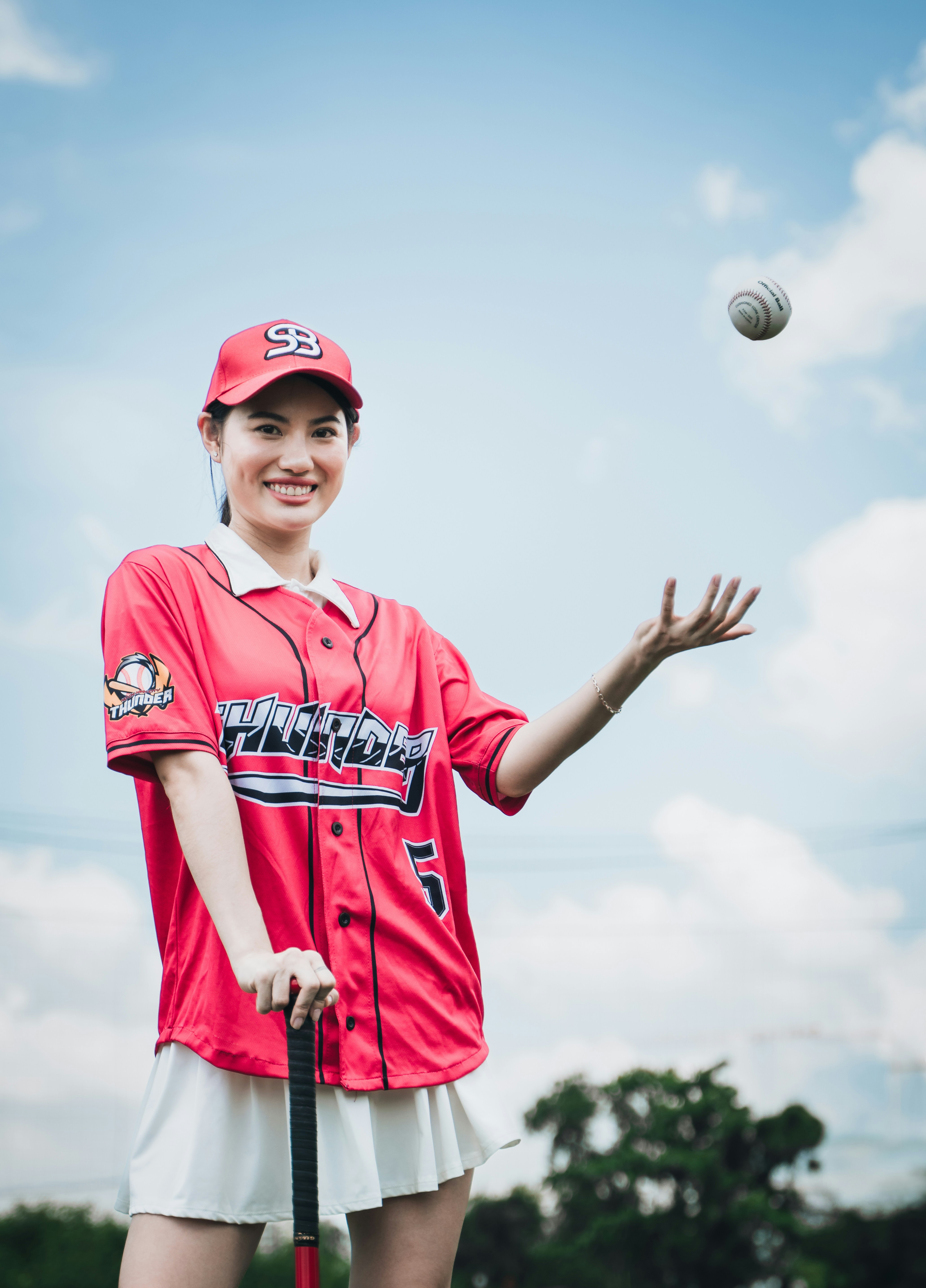 Scarlet Batter Under a Powder-Blue Sky: A Moment of Play