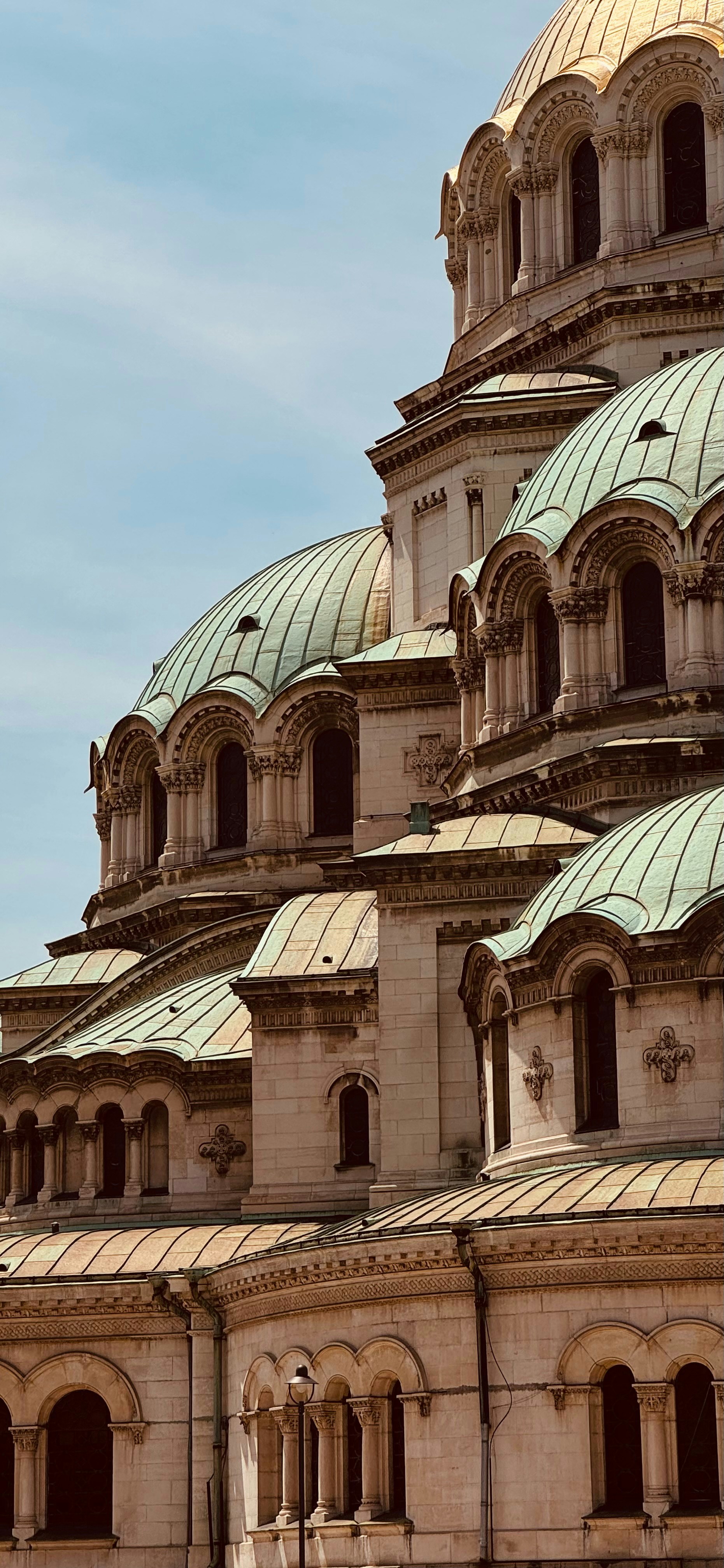 Copper Dome Cascade: Layered Domes and Arched Facades in Warm Light