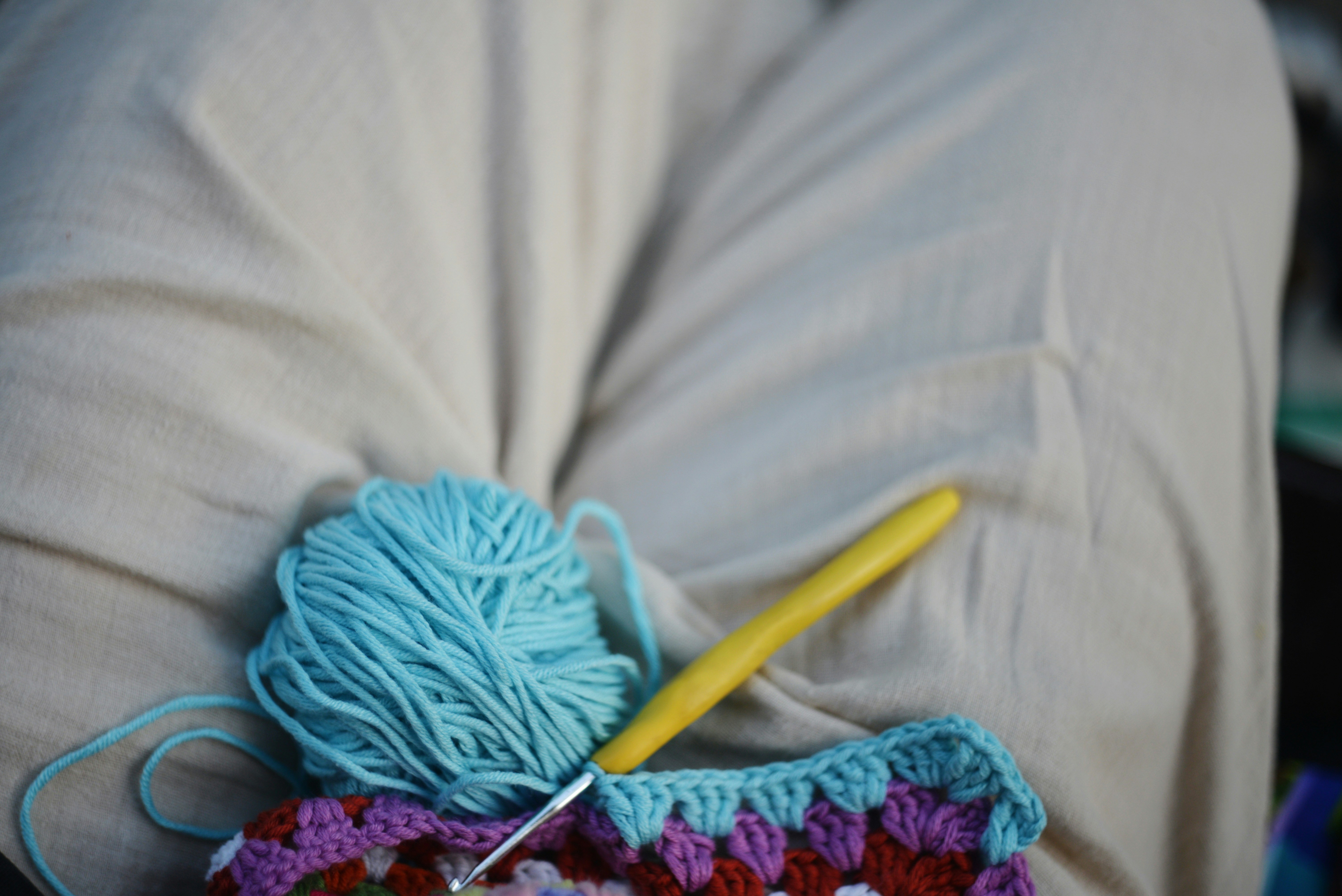 Crocheting with blue yarn is in progress. photo – Free Man Image on ...