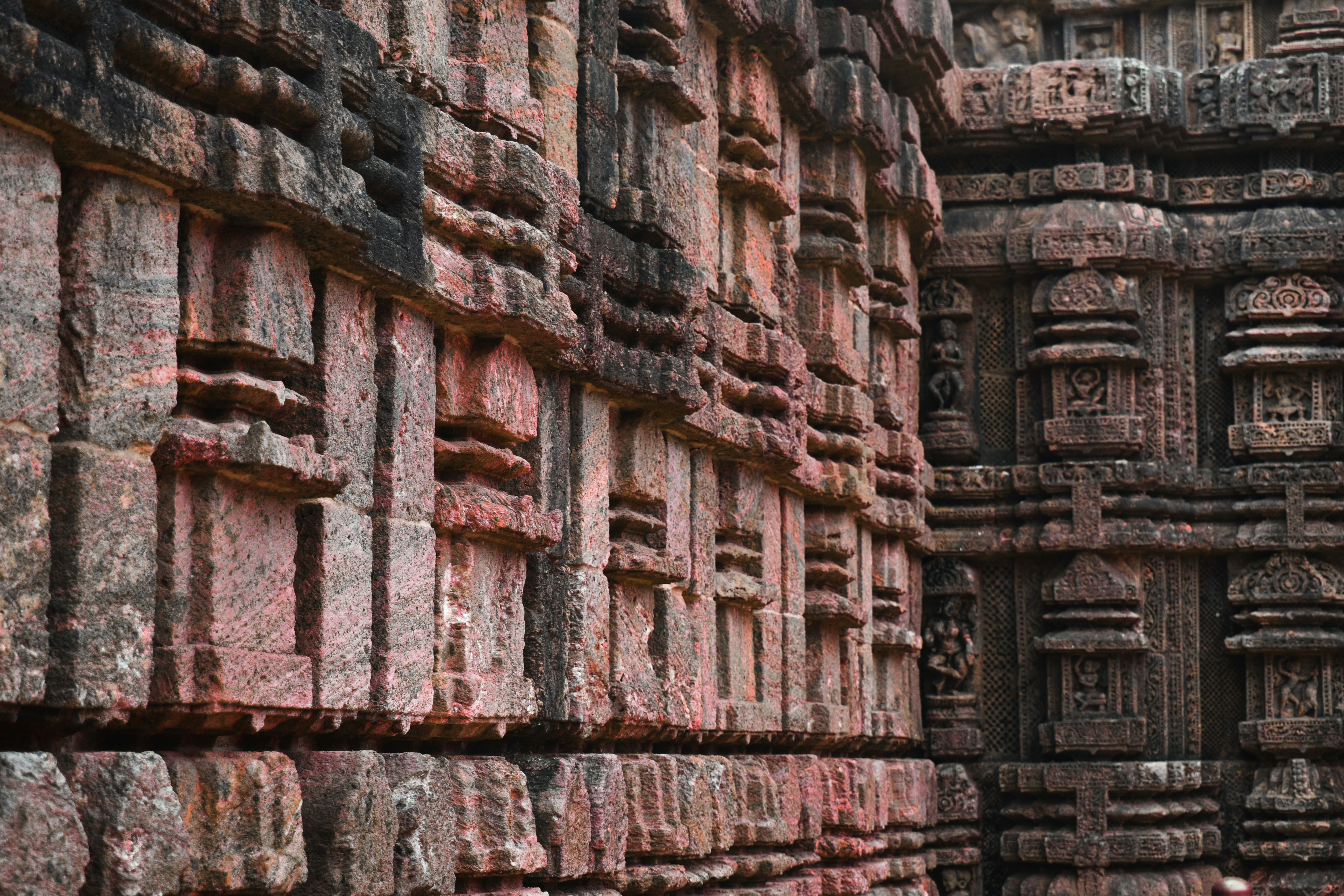 Ancient stone wall architecture shows intricate carvings.