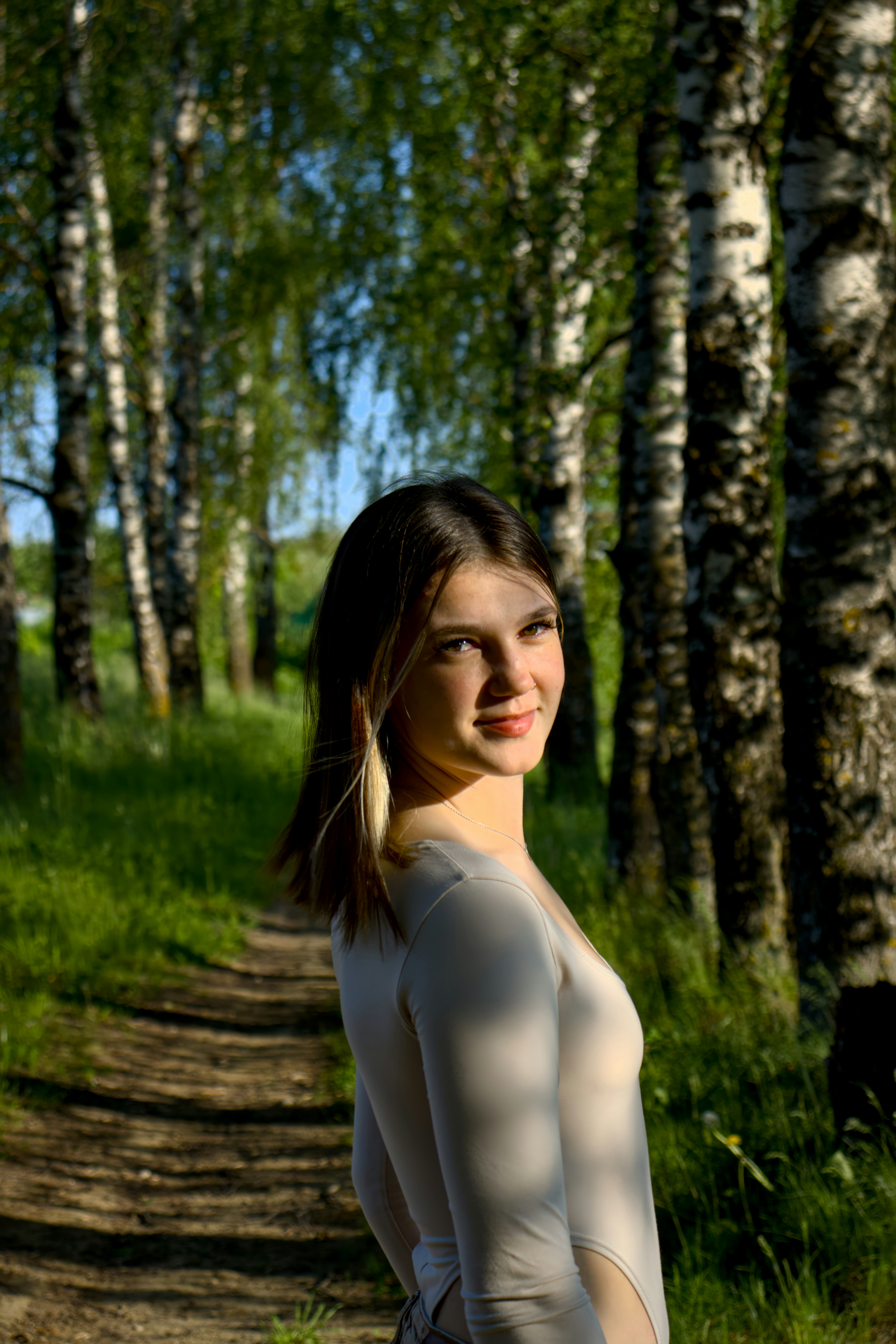 A young woman smiles in a birch tree forest. photo – Free Forest Image ...