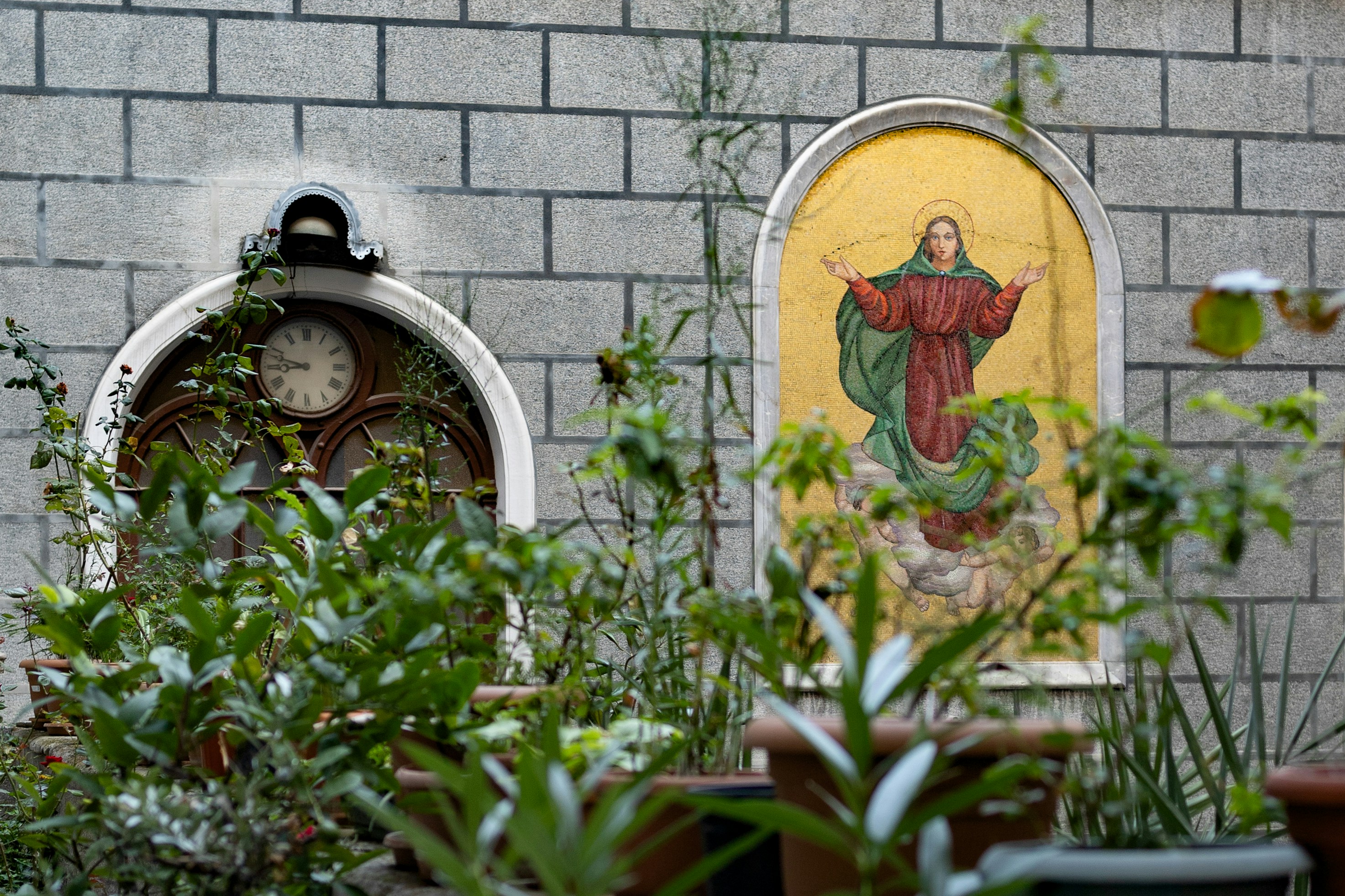 Outdoor Shrine Courtyard: Greenery Framing a Sacred Mural and Clock