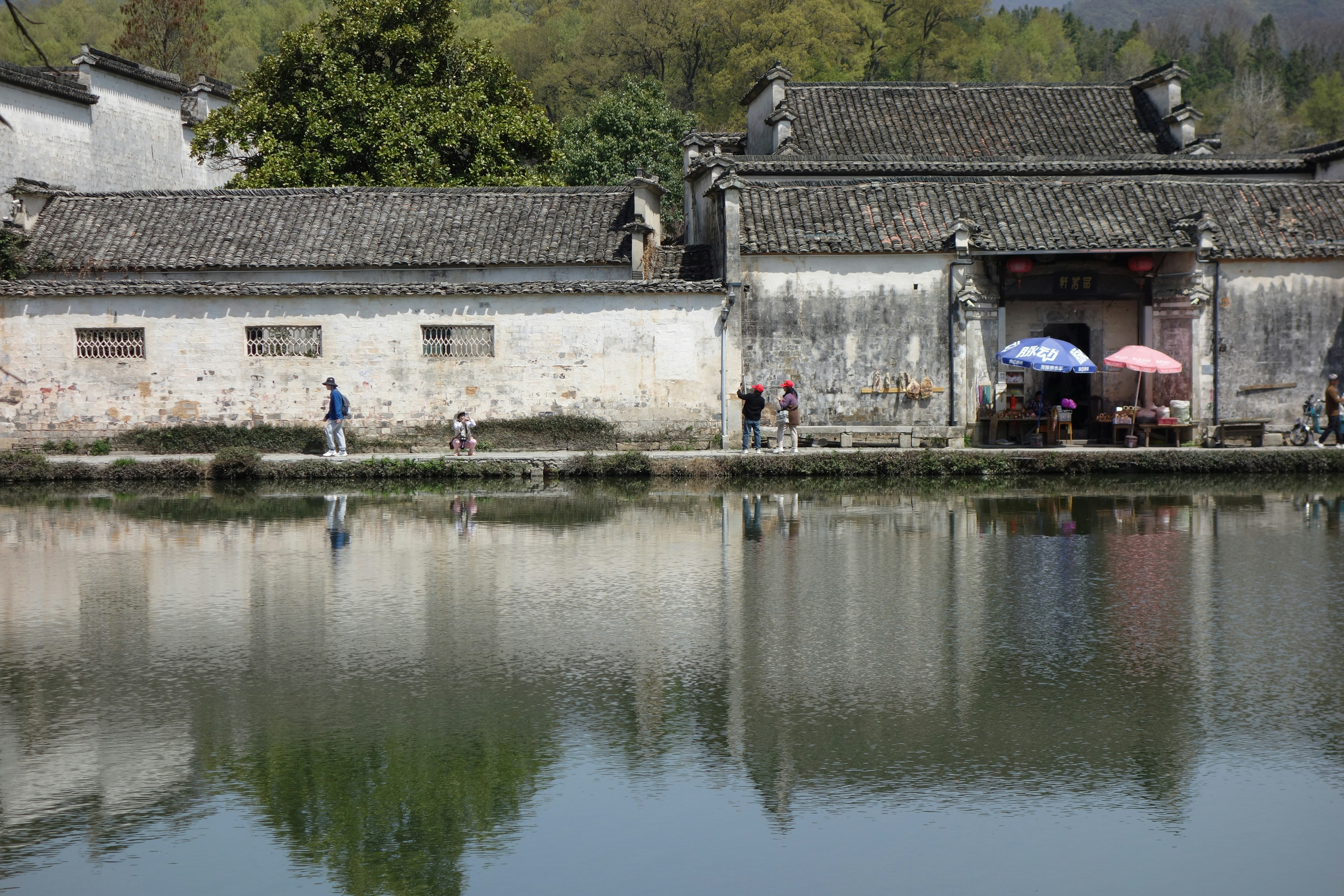 Umbrellas by the White-Walled Riverside Gate